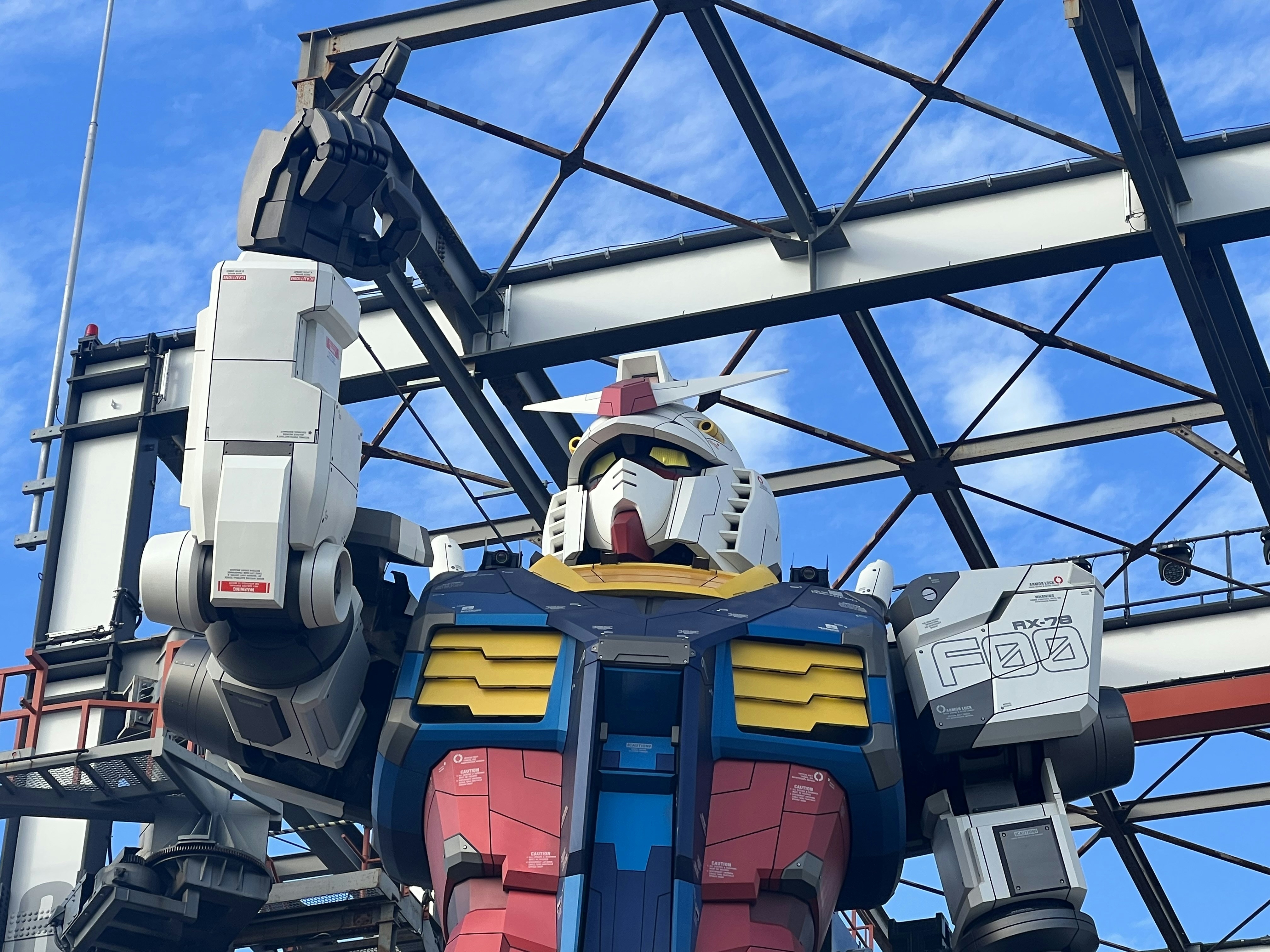 Giant robot sculpture with vibrant colors against a blue sky.