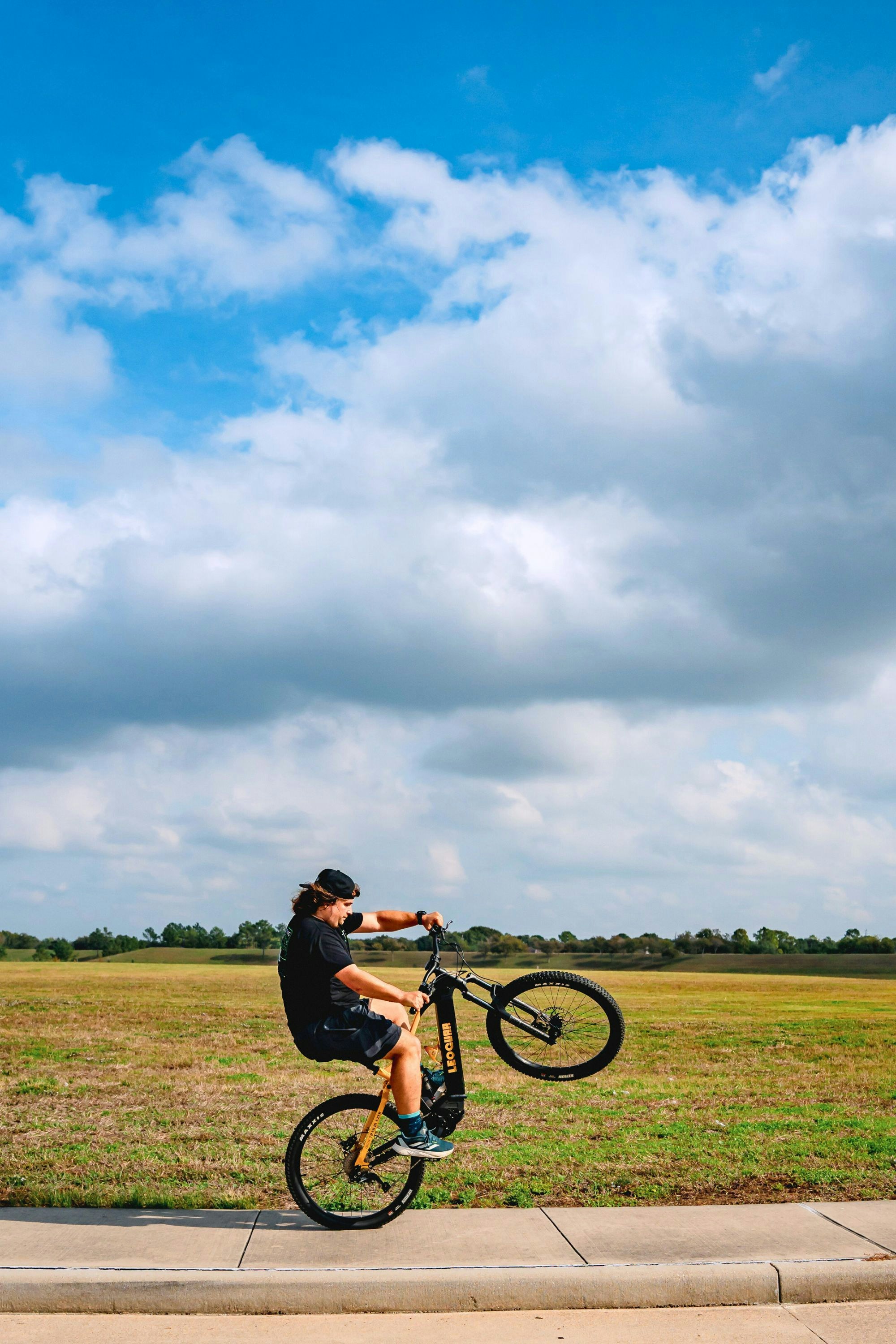 A man on a bike doing a trick in the air photo – Free Male Image on ...