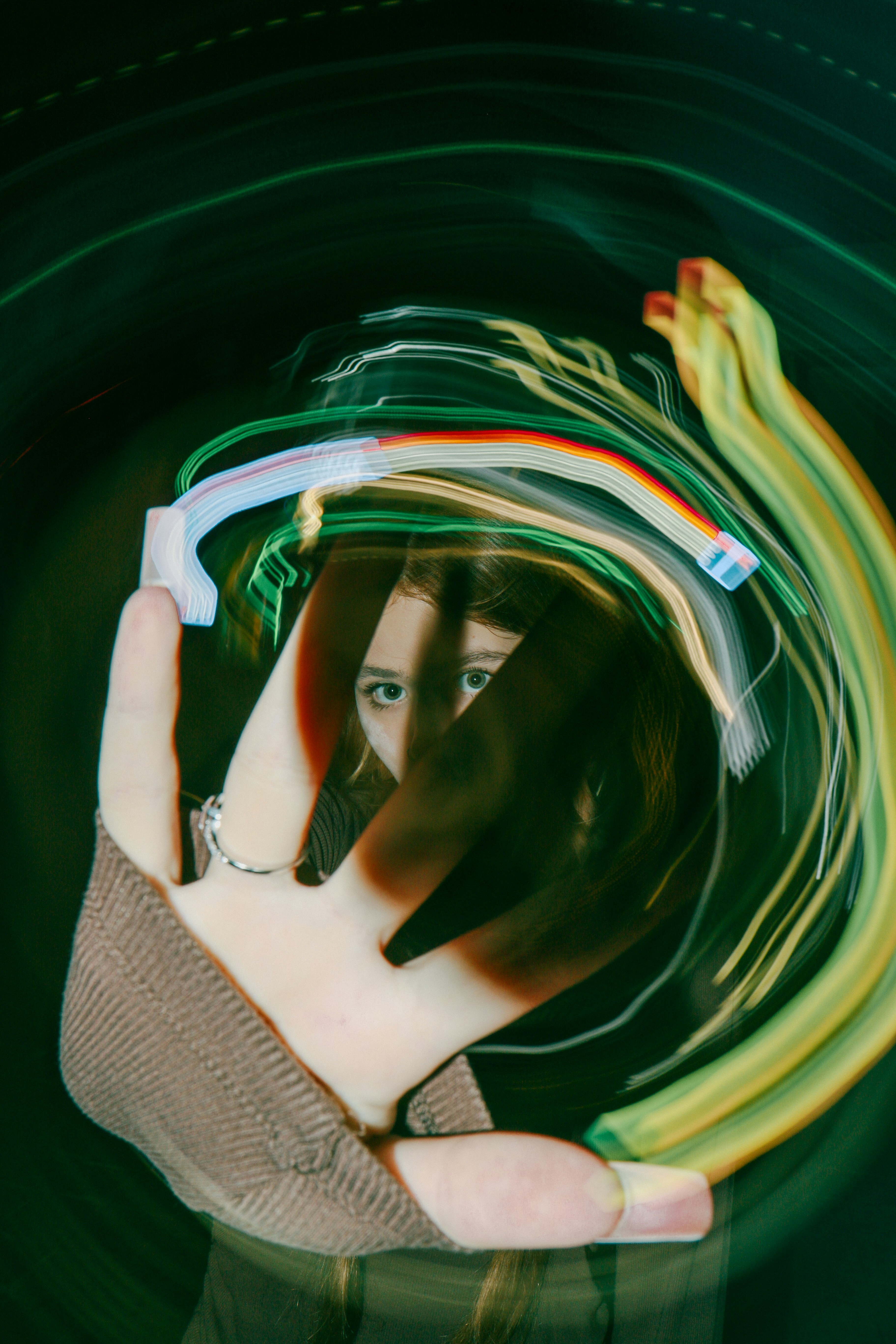 A woman is holding a colorful object in her hands photo – Free ...