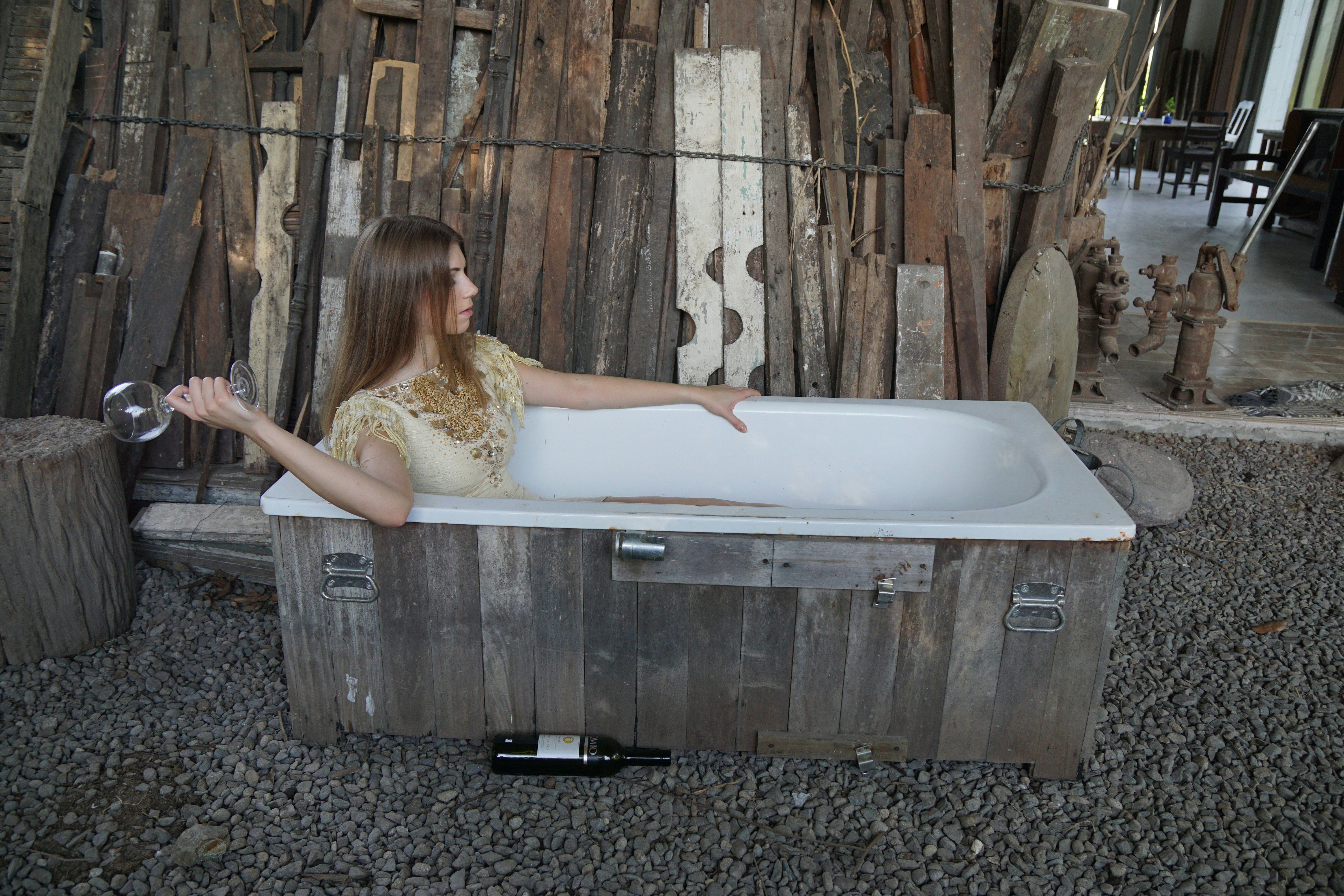 A woman sitting in a large outdoor bathtub photo – Free Fashion Image ...