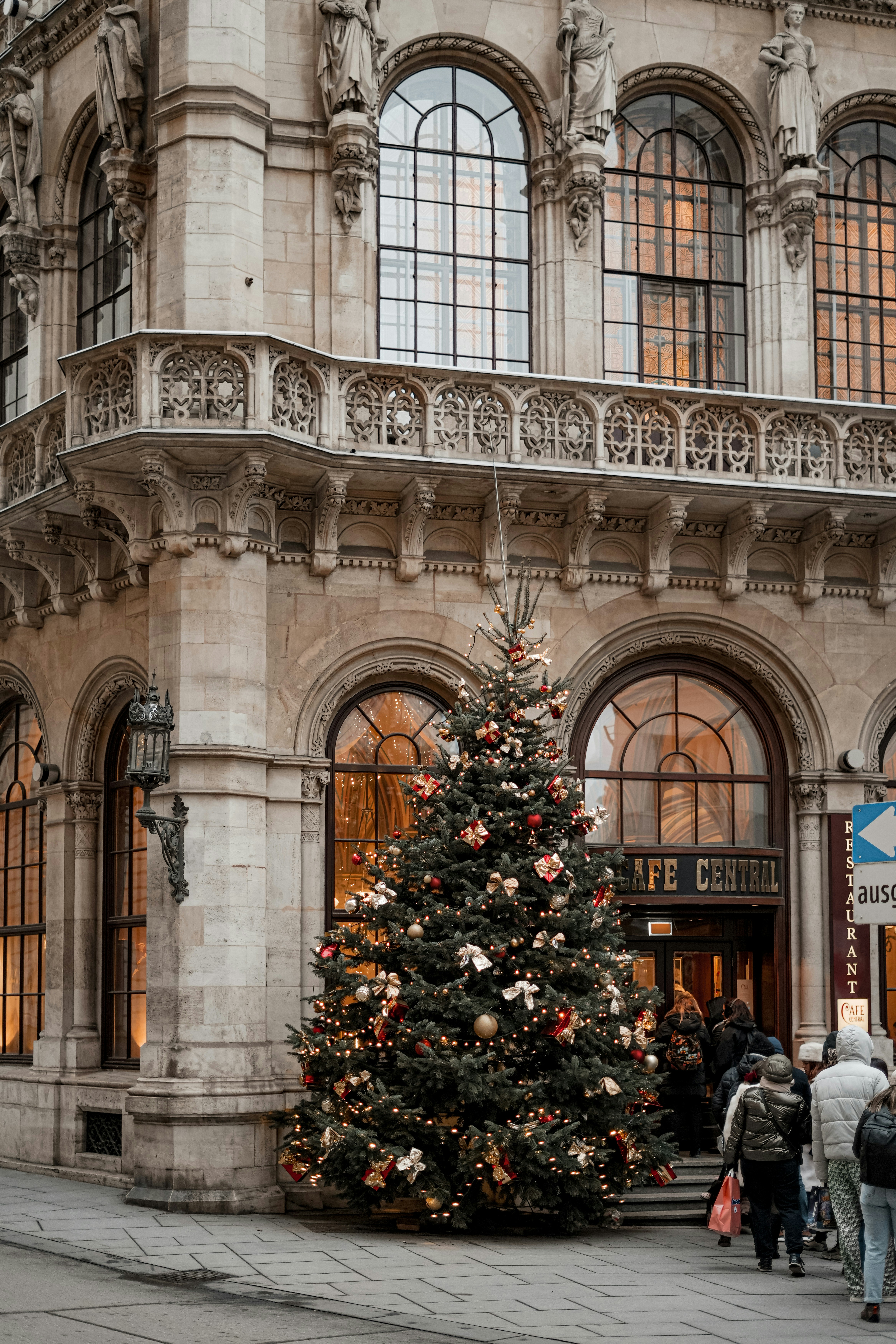 A large building with a christmas tree in front of it photo – Free ...