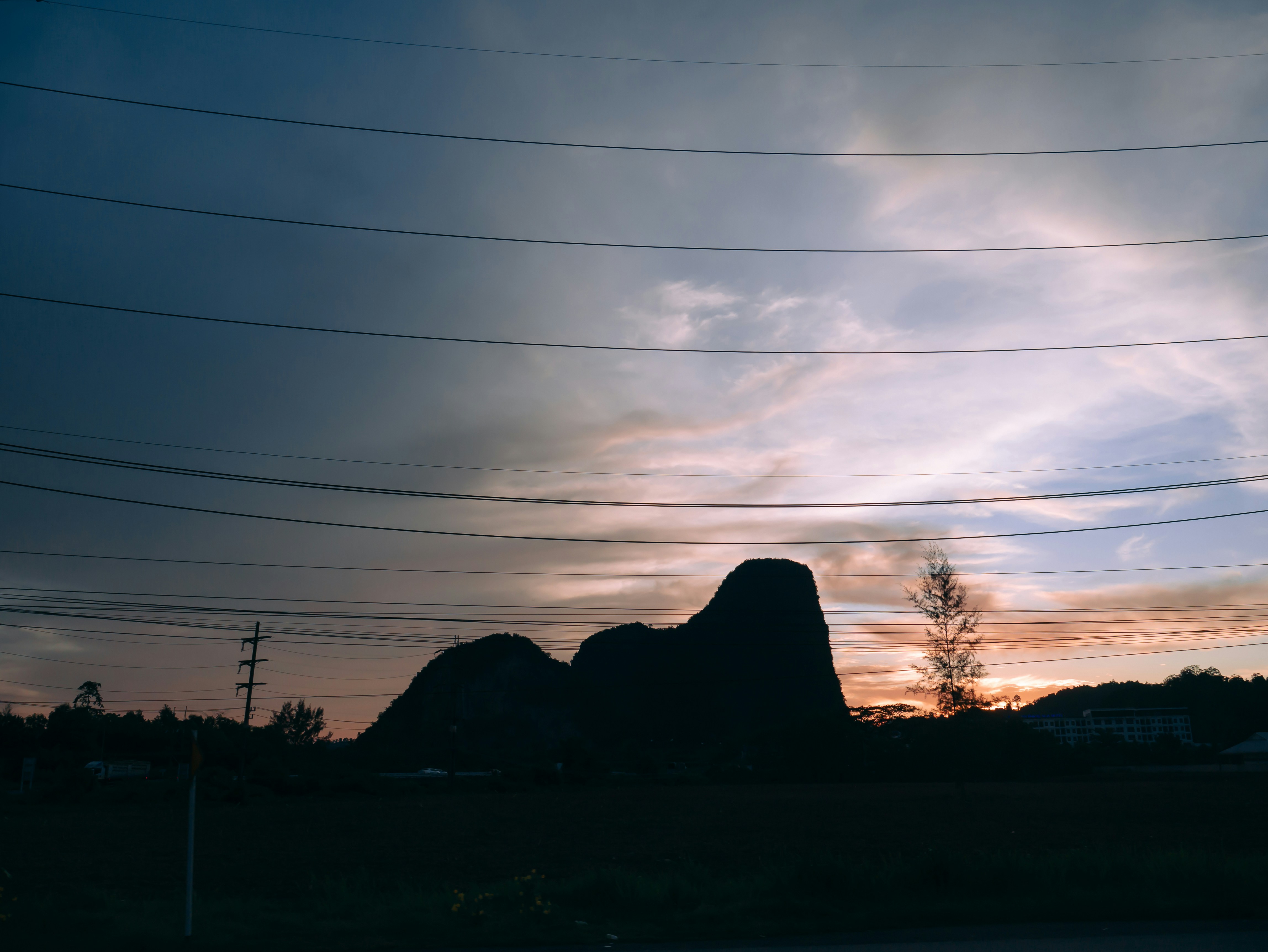The sun is setting behind a rock formation photo – Free Thailand Image ...
