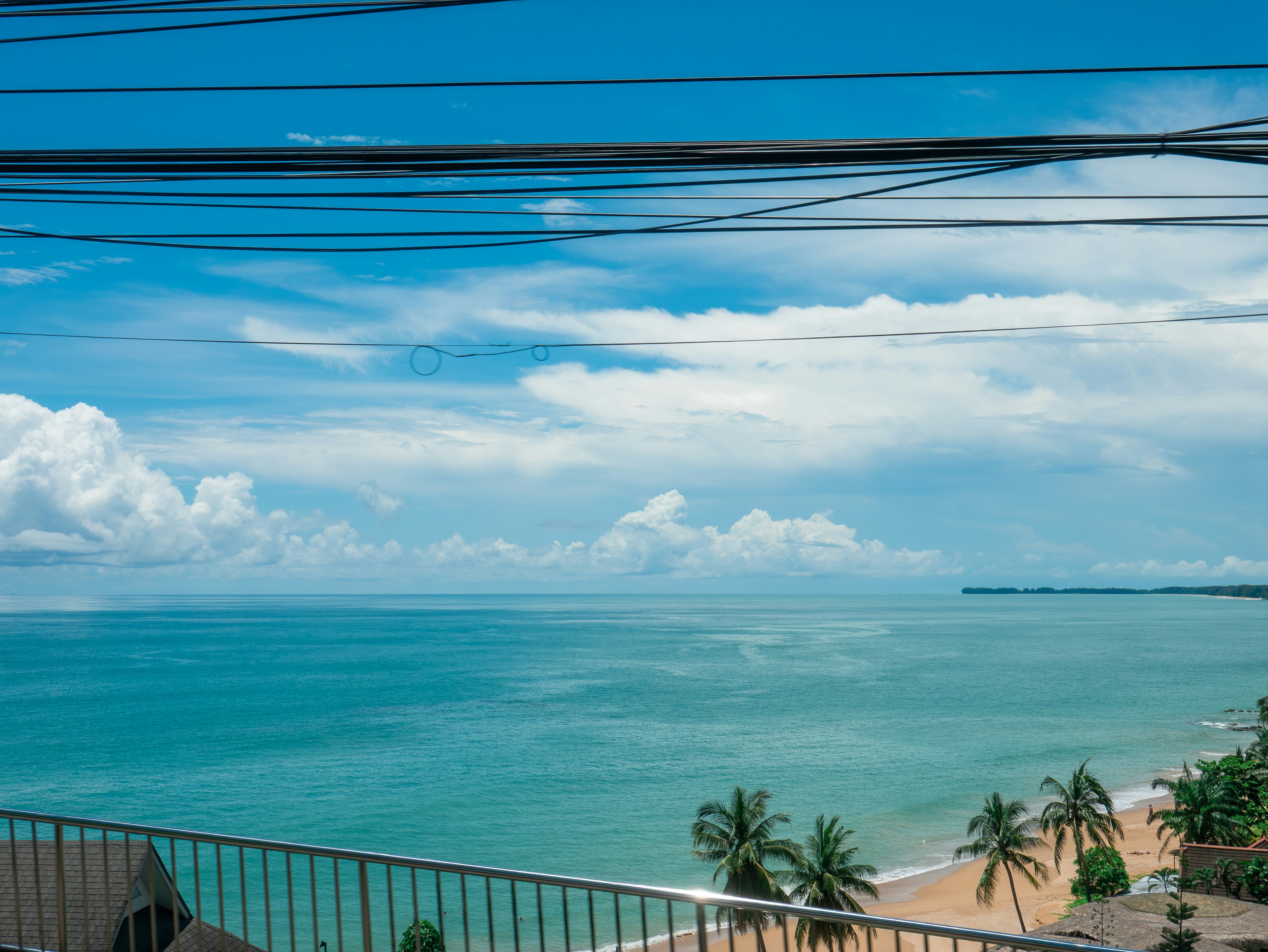 Balcony Overlook: Palm-Lined Beach and Horizon Over Turquoise Waters