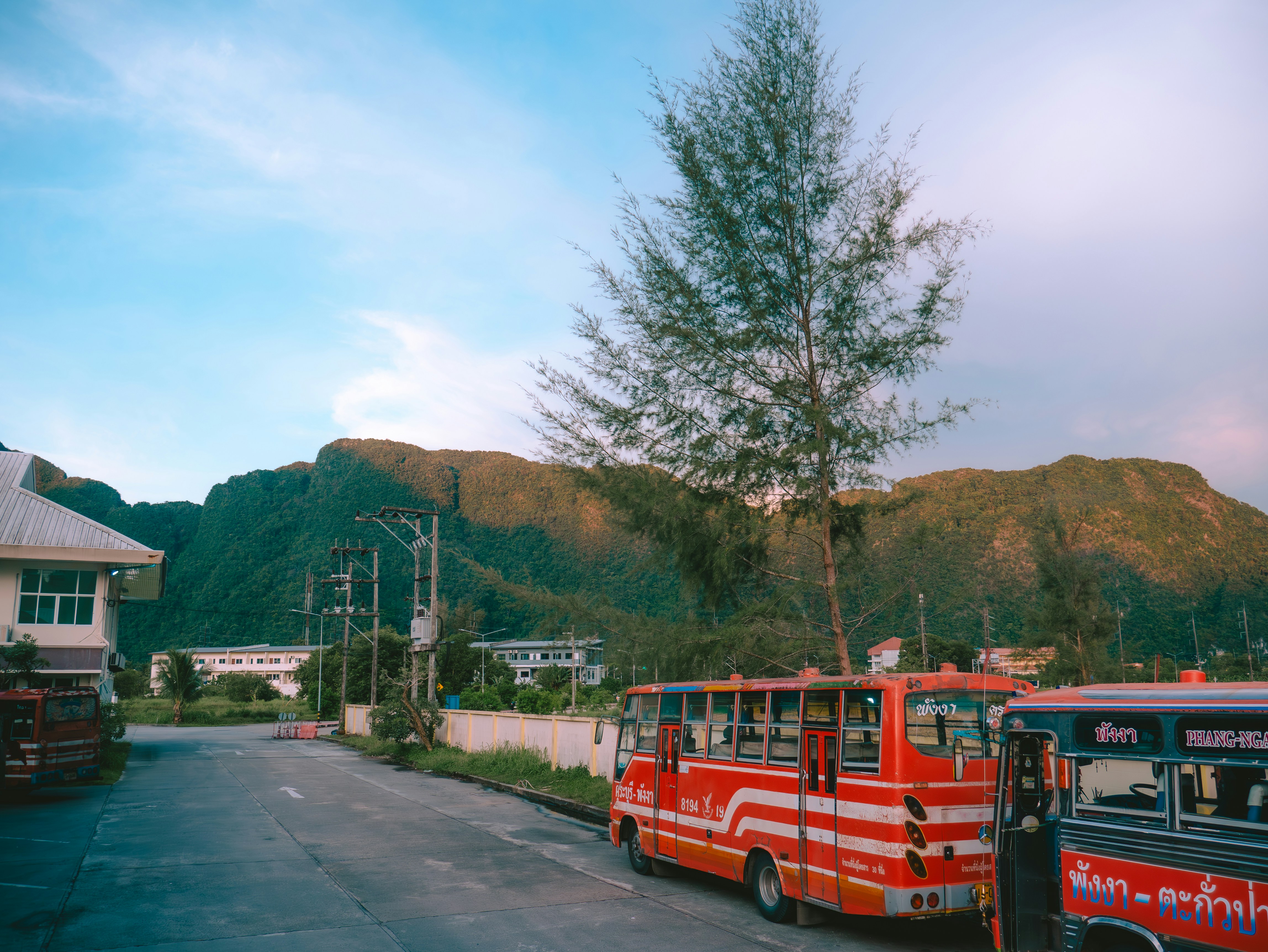 A couple of red buses parked next to each other photo – Free Travel ...