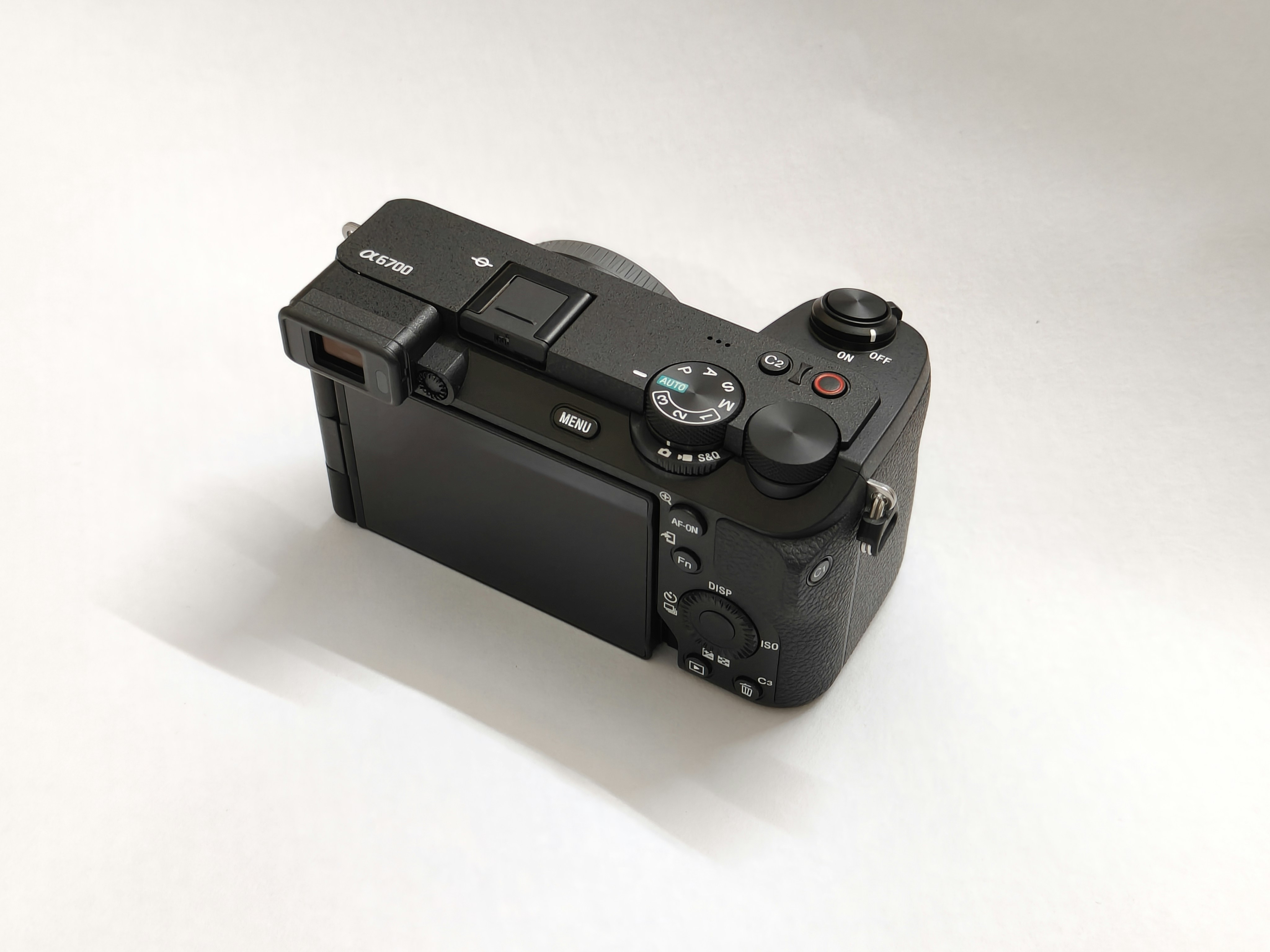 A black camera sitting on top of a white table