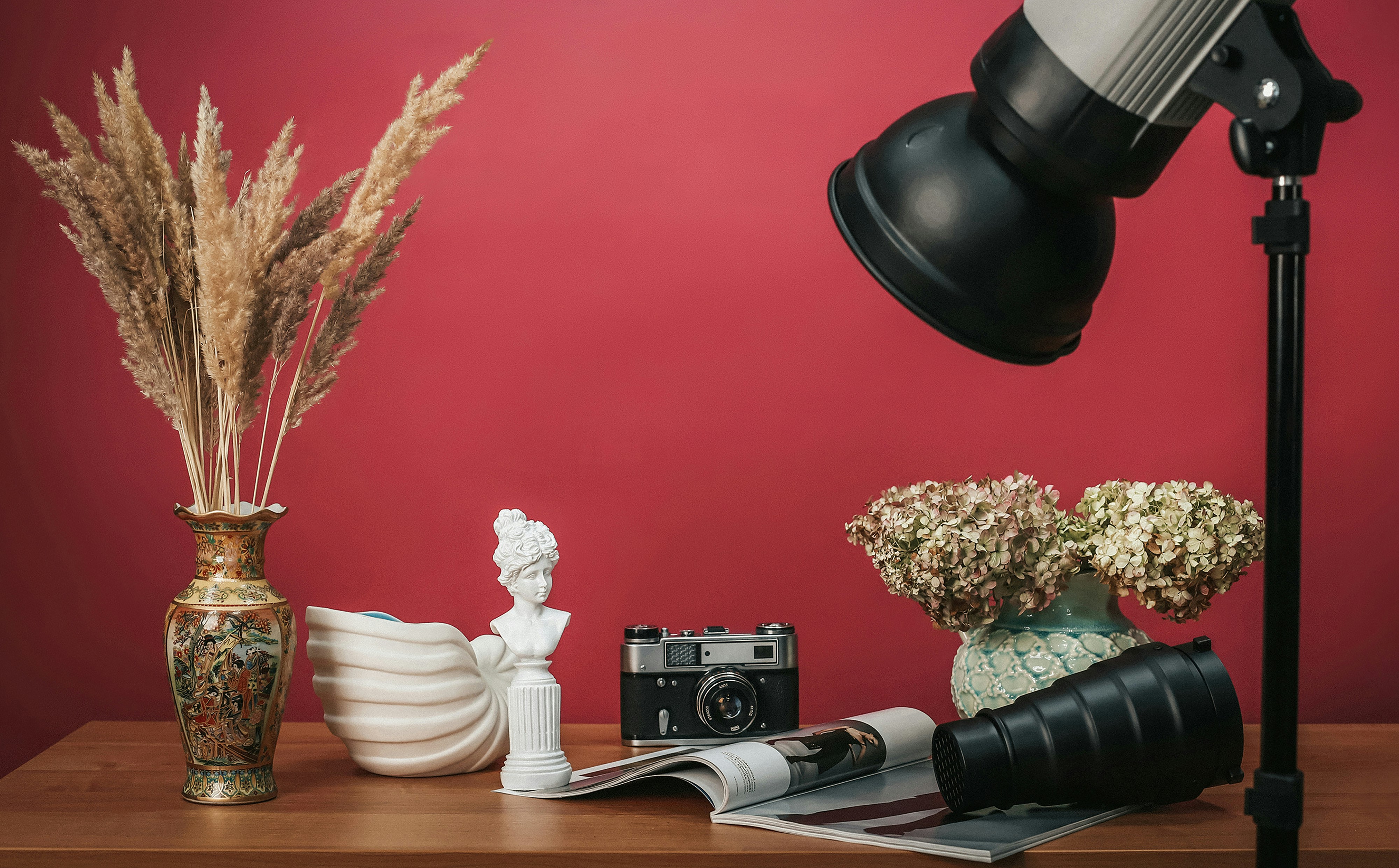 A desk with a camera, vases and a lamp photo – Free Plant Image on Unsplash