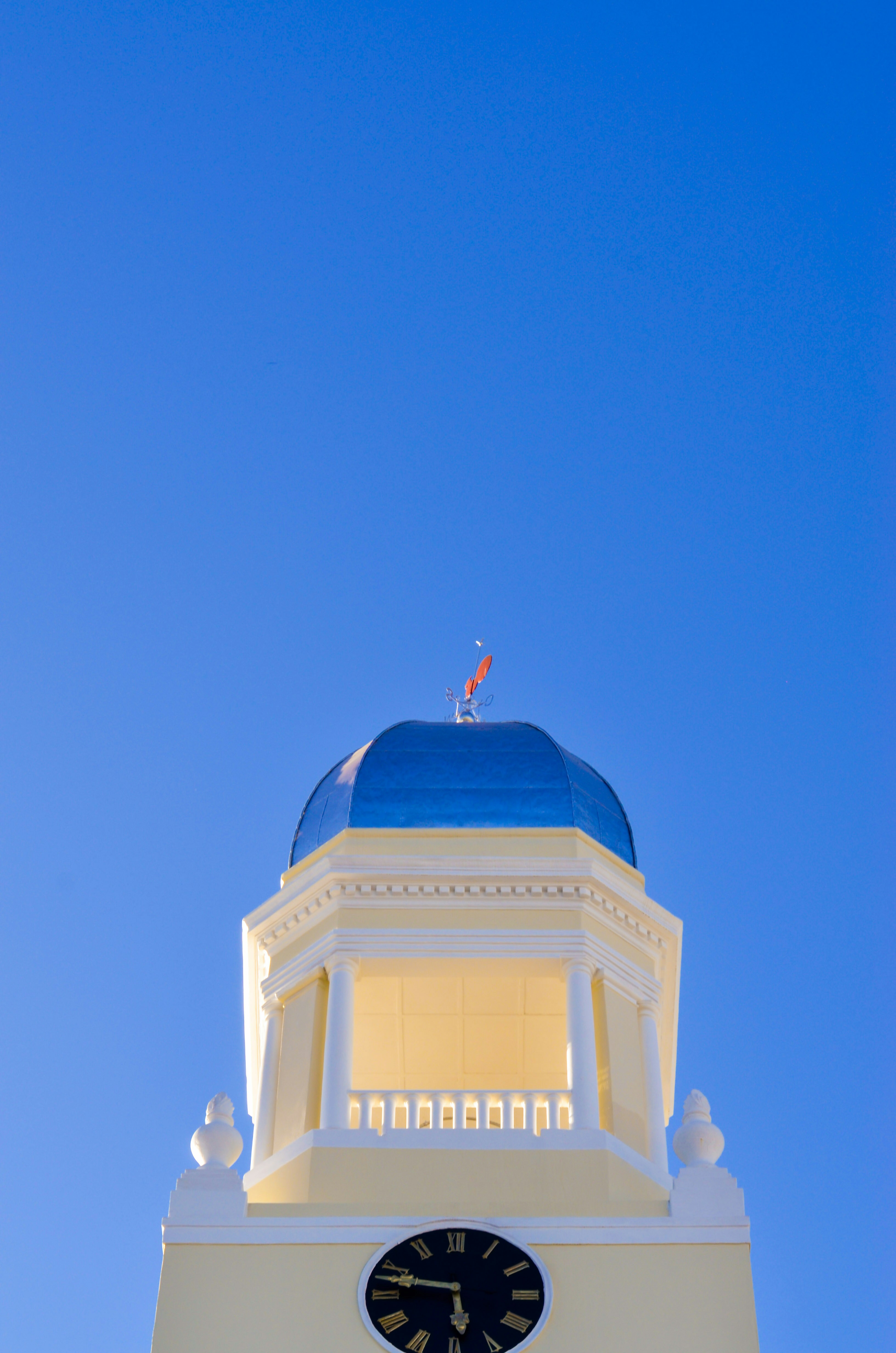 A white clock tower with a blue dome on top photo – Free Wallpaper ...
