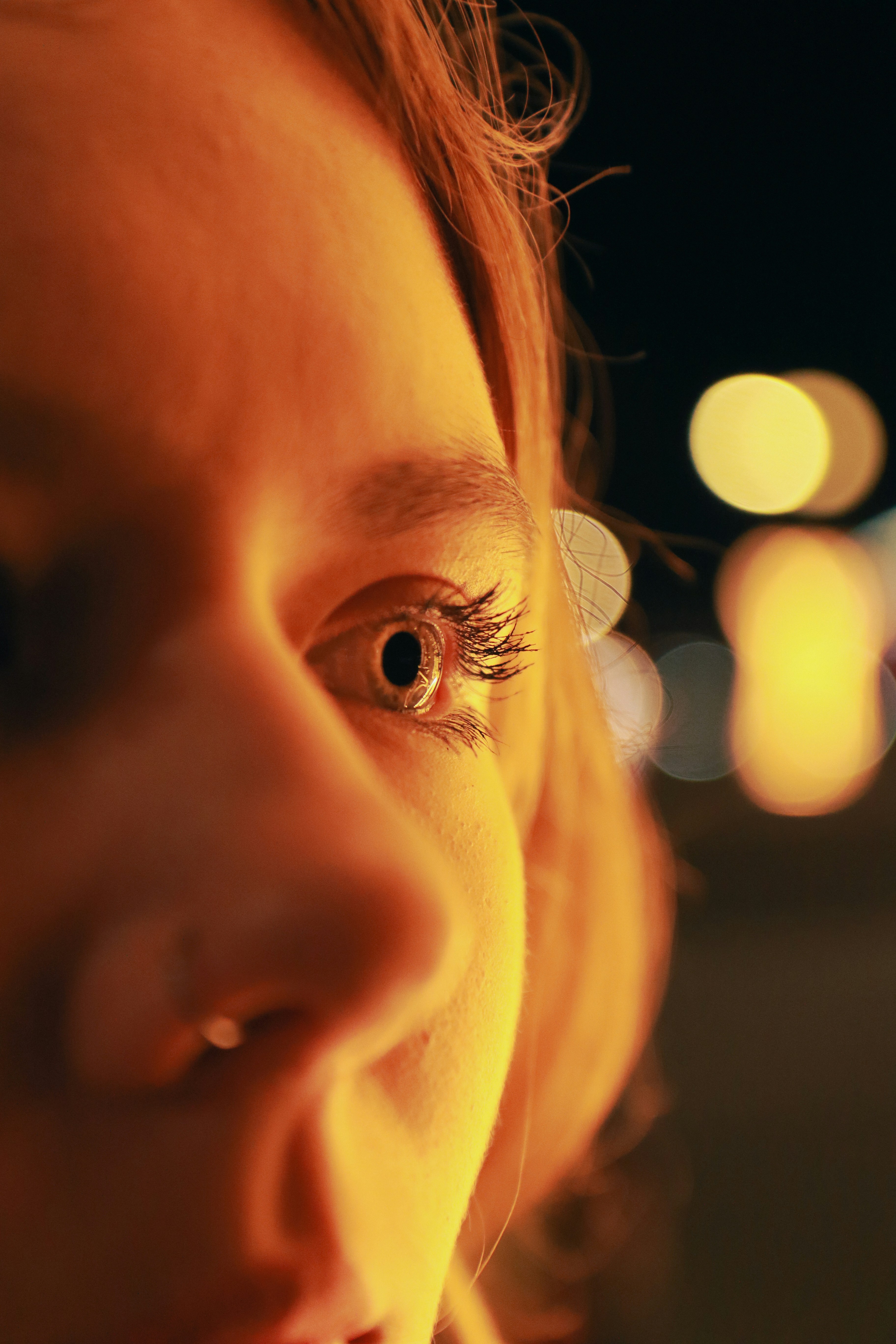 Amber Gaze: Close-Up Portrait Framed by Neon Orbs