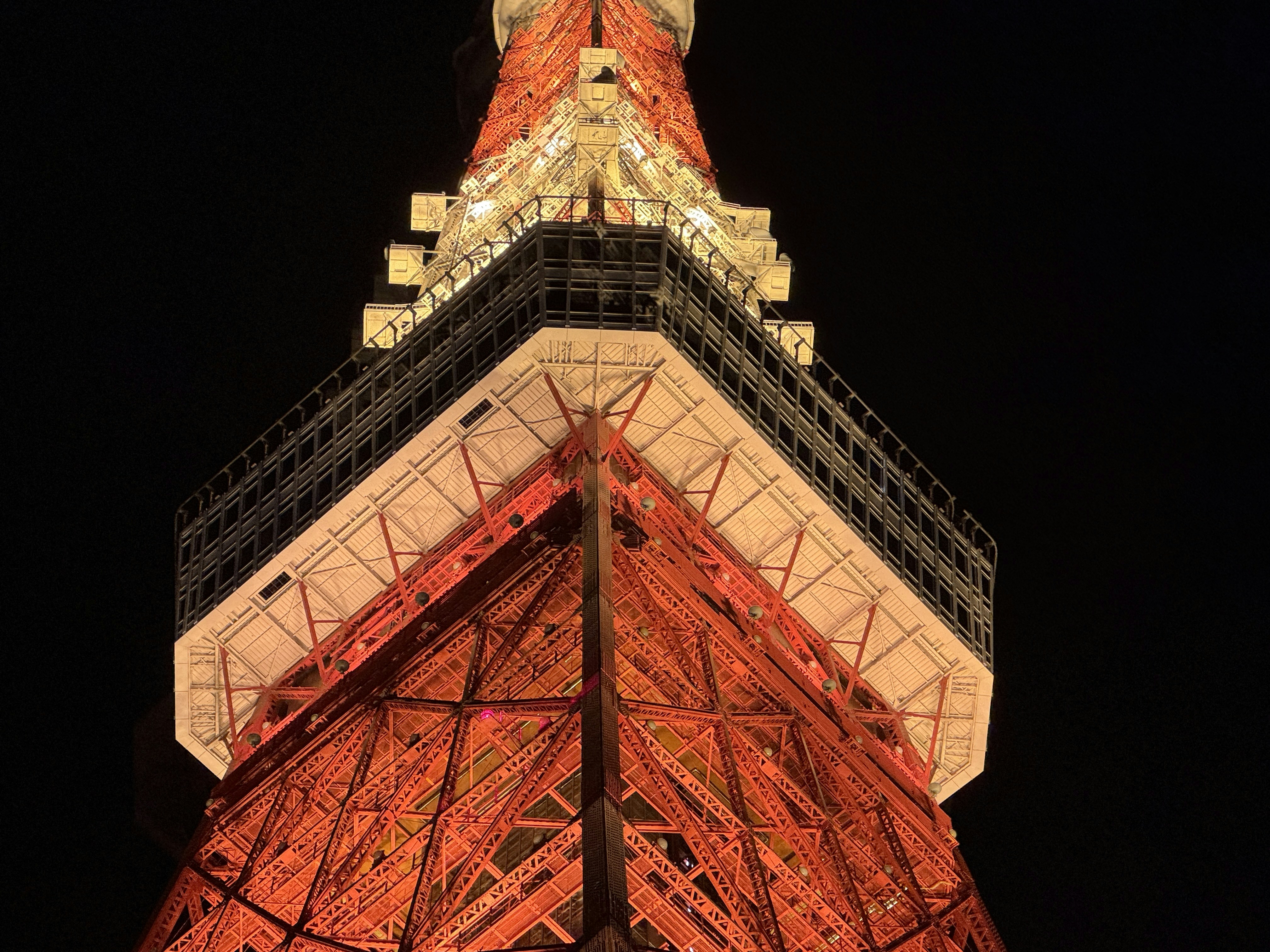 Crimson Lattice Ascending: Night View from Ground Up