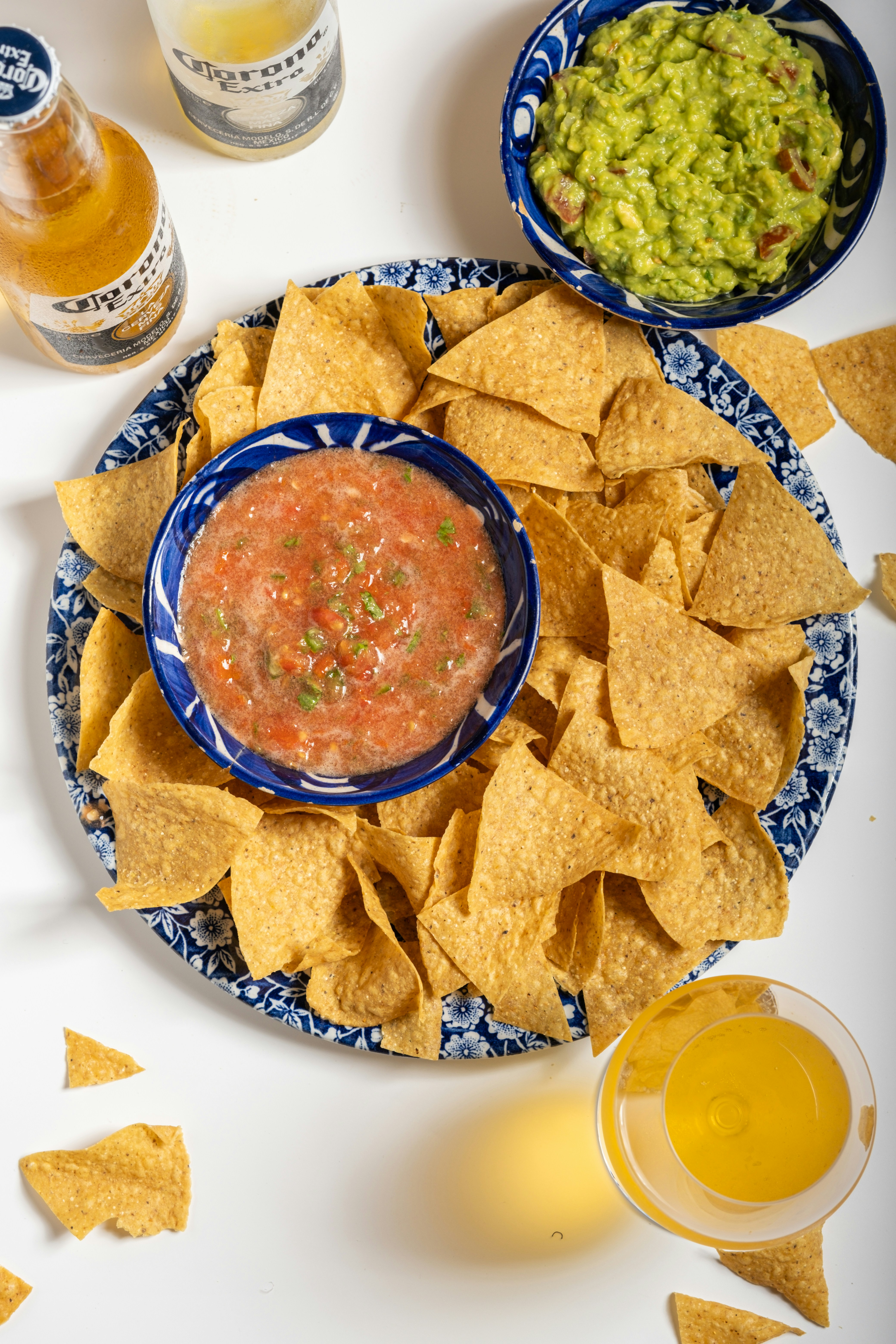 A plate of chips, salsa, and beer on a table photo – Free Mexican food ...