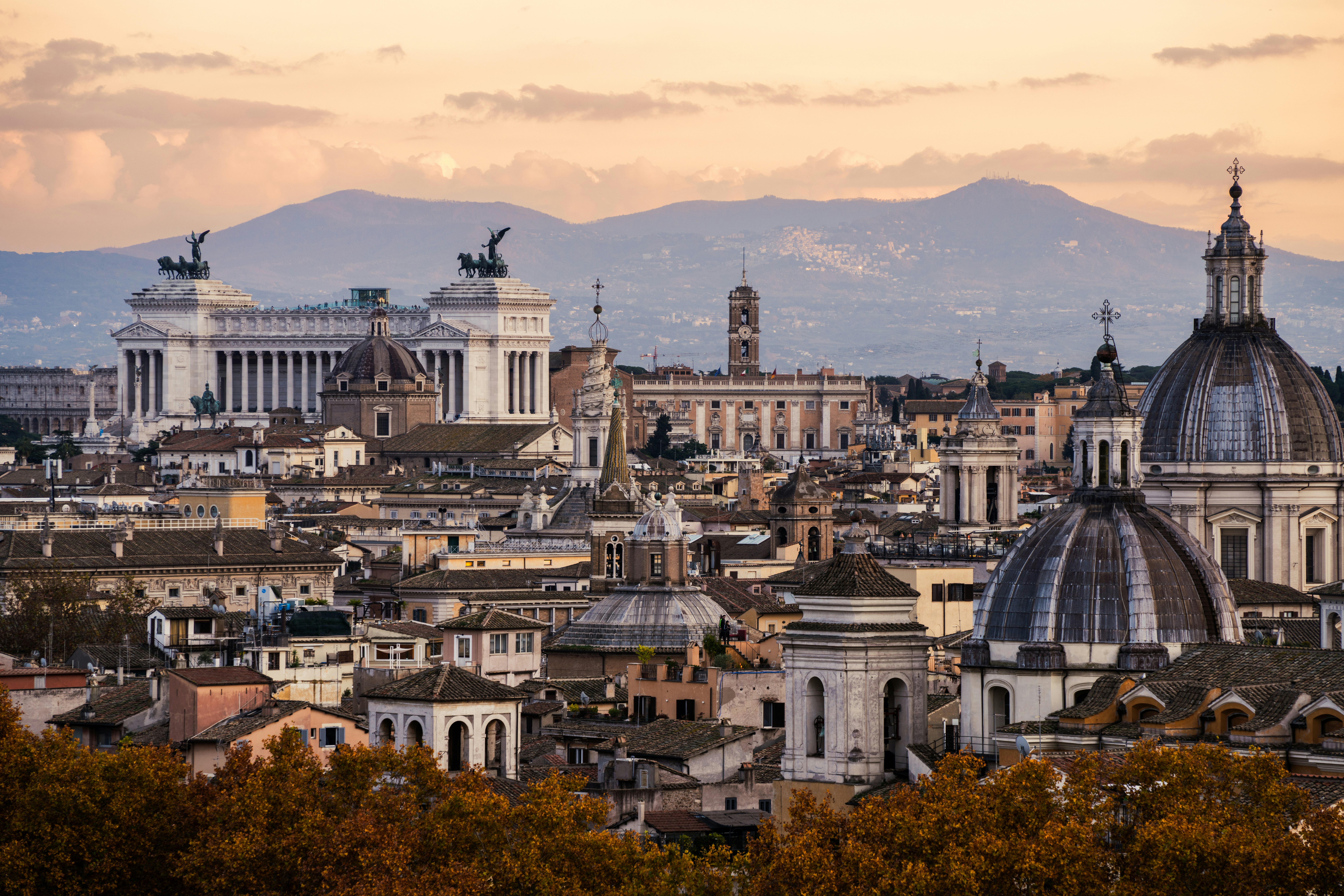 A view of the city of rome with mountains in the background photo ...