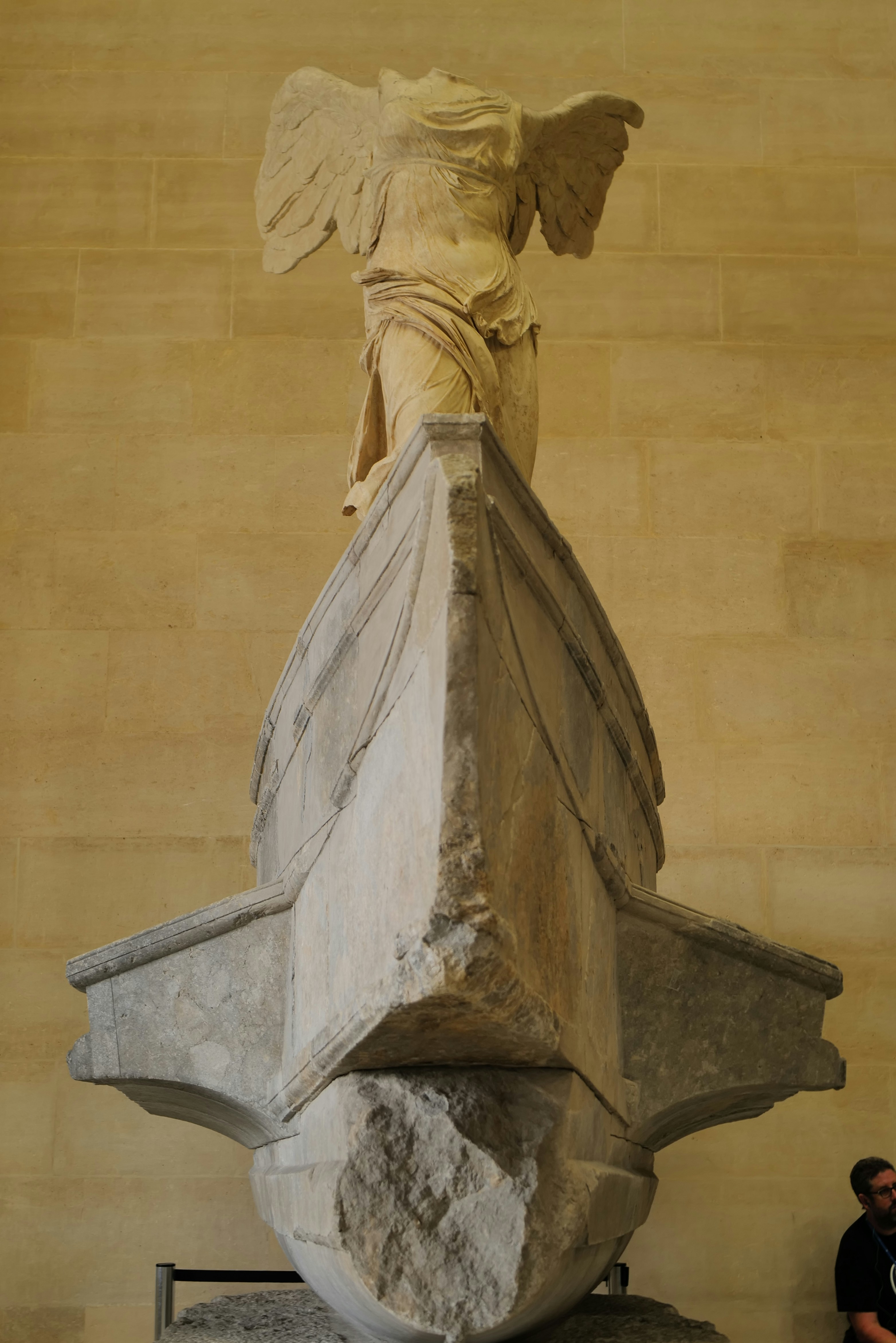 Winged Guardian on Warm Stone: A Static Poise in Marble and Light