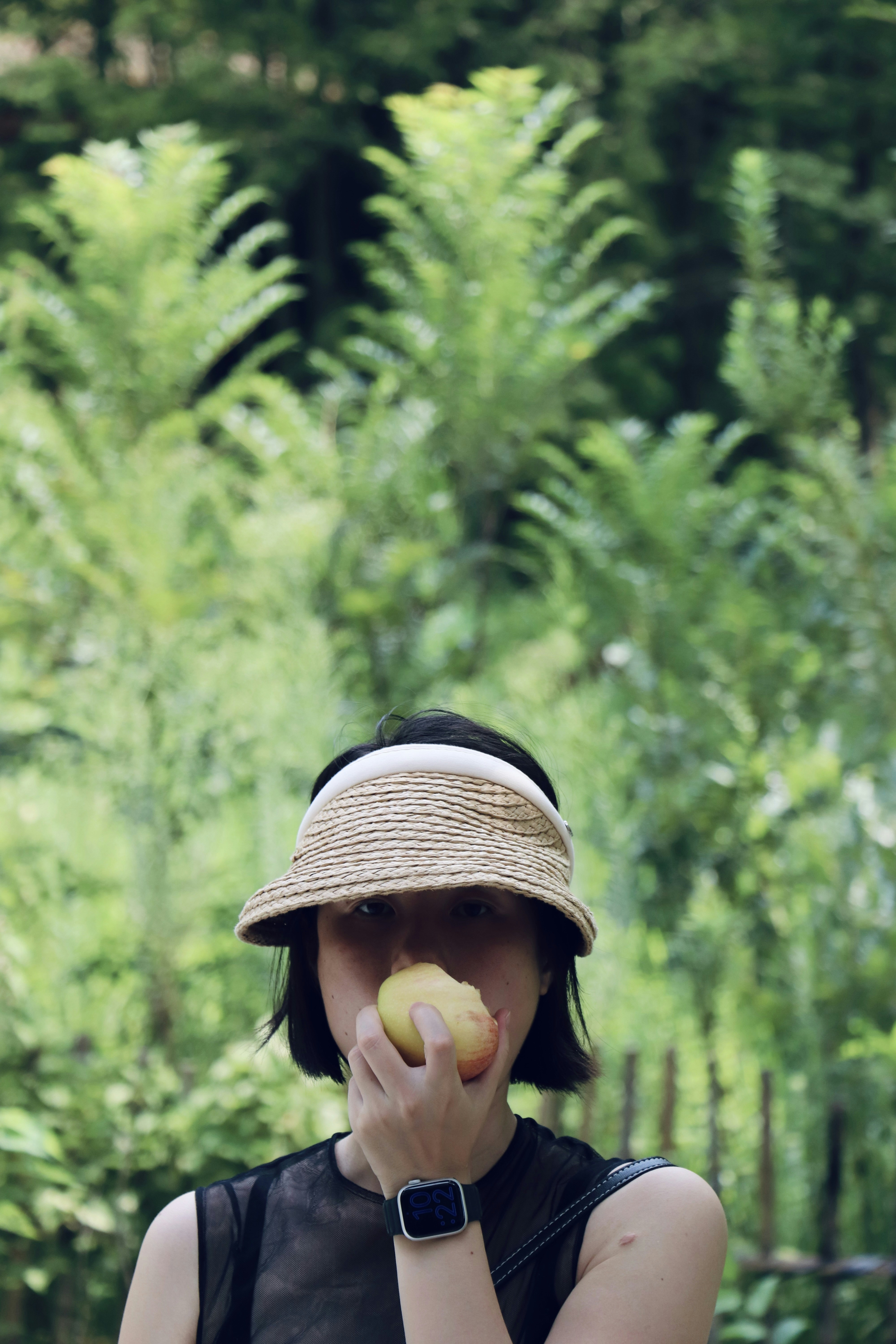 Hidden Harvest: A Sunhat Portrait in Greenery