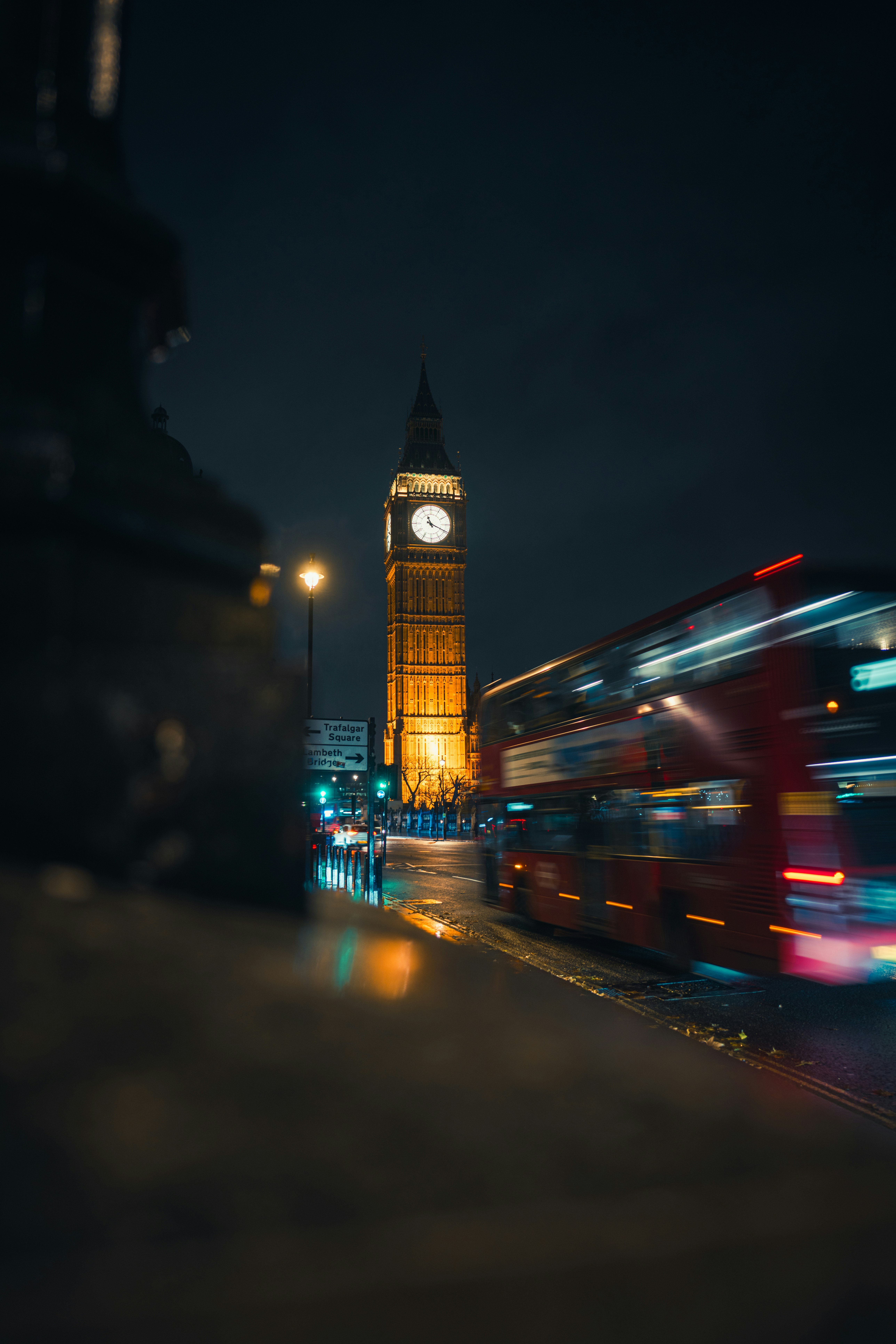 Big Ben in Focus, Blurred Red Bus: A Nocturnal London Street Scene