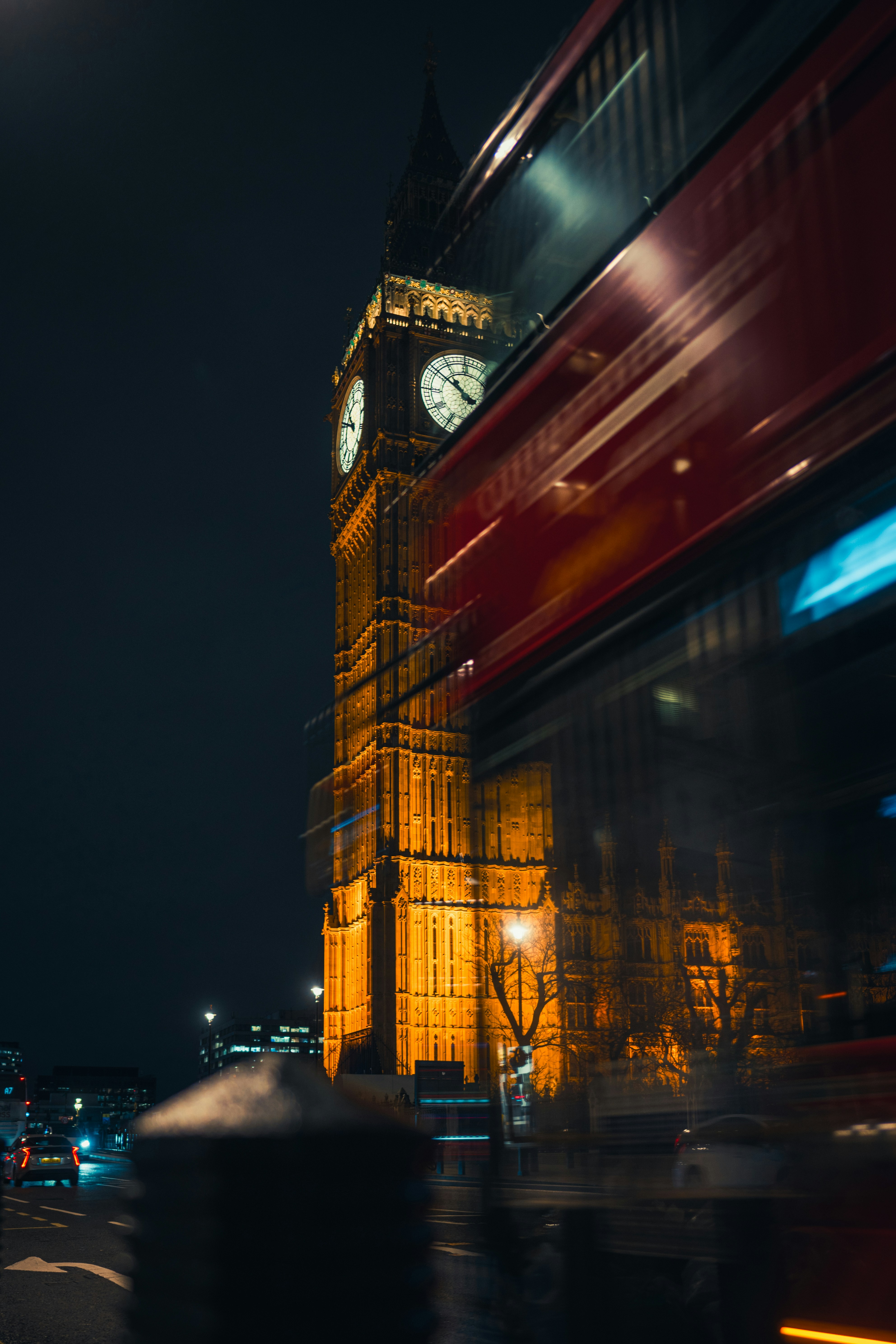 Hour Hand in the Night: Big Ben Framed by a Rushing Red Bus