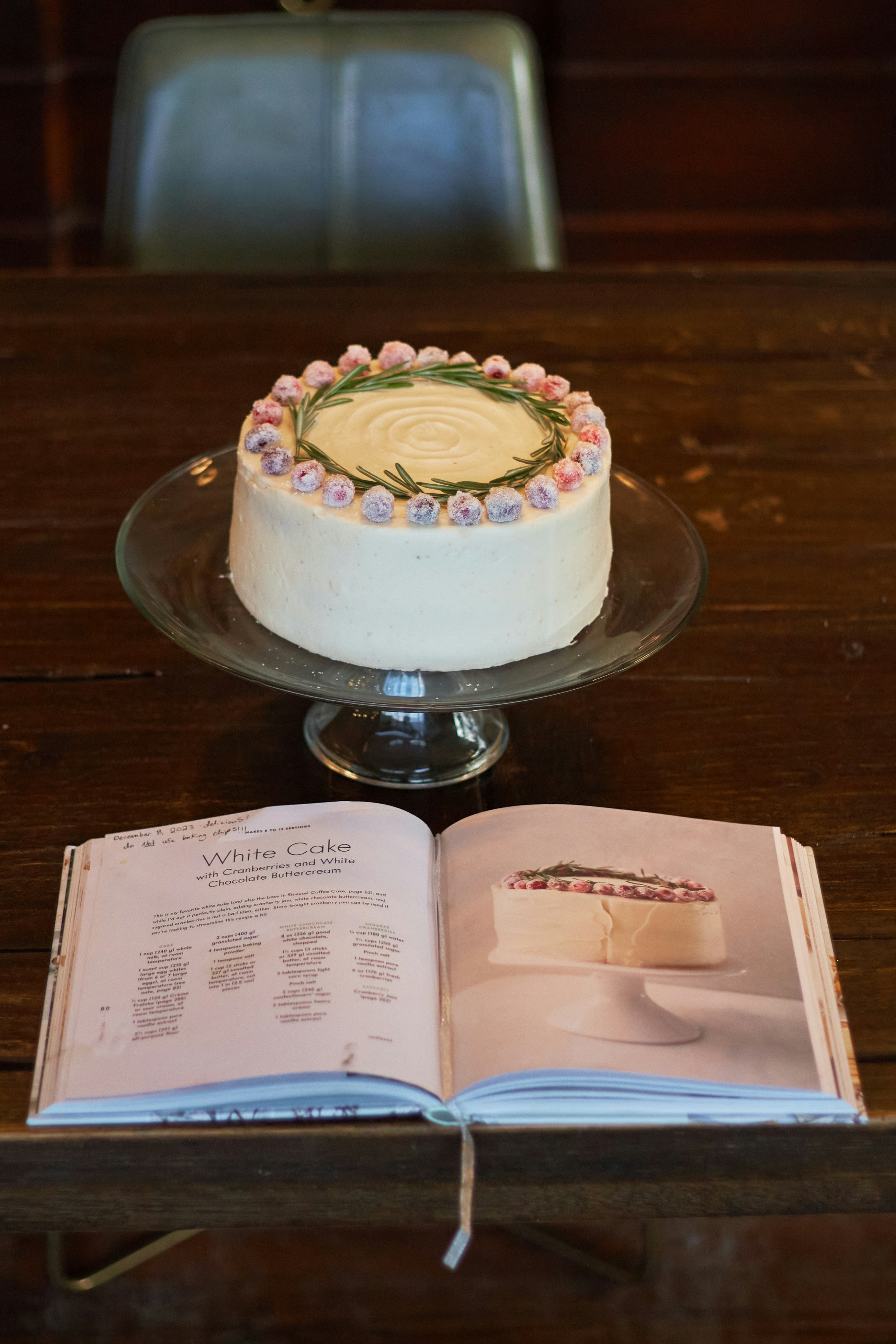 Cake topped with Cranberries and rosemary with recipe book