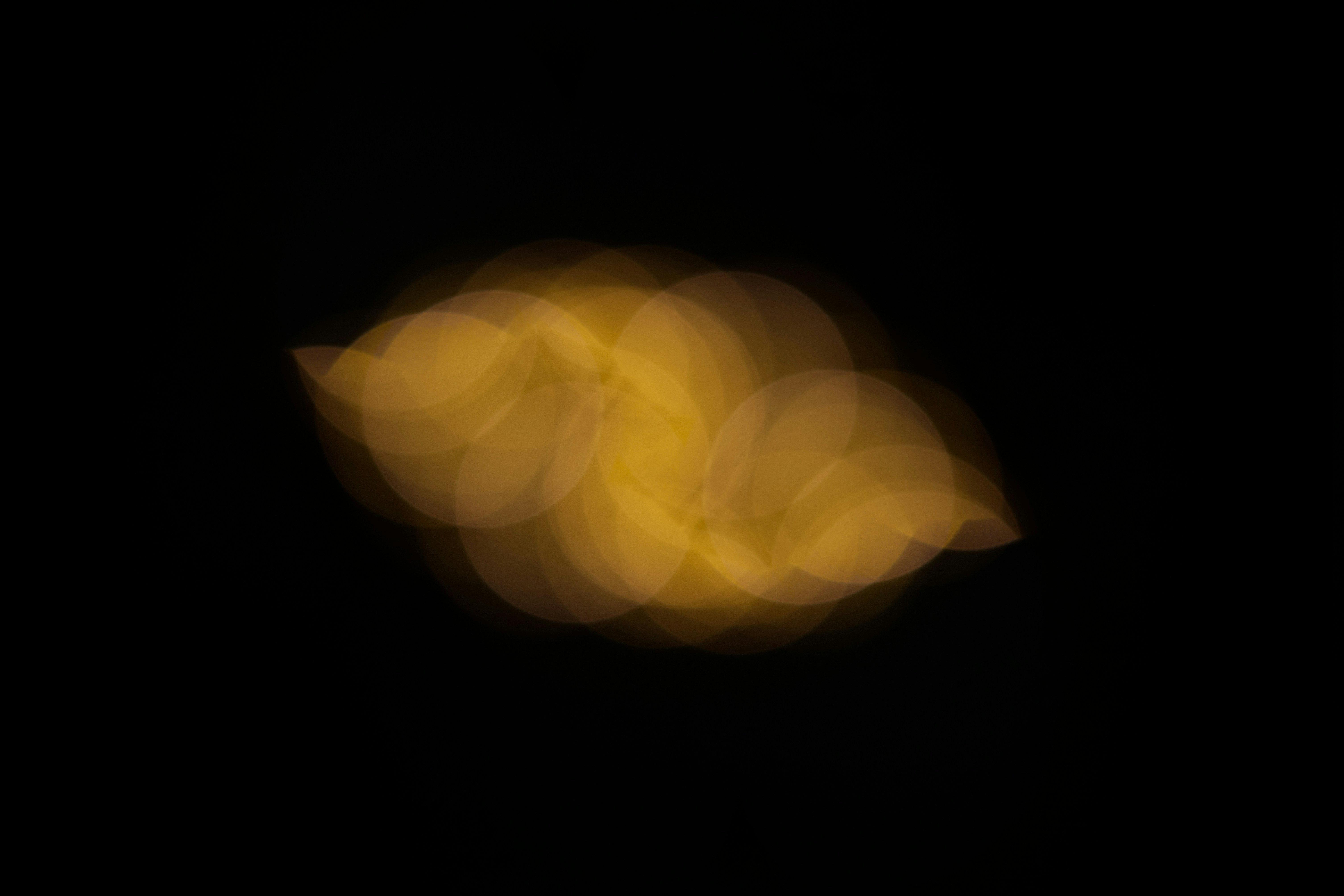 Amber Orbs in Velvet Darkness: An Abstract Bokeh Study