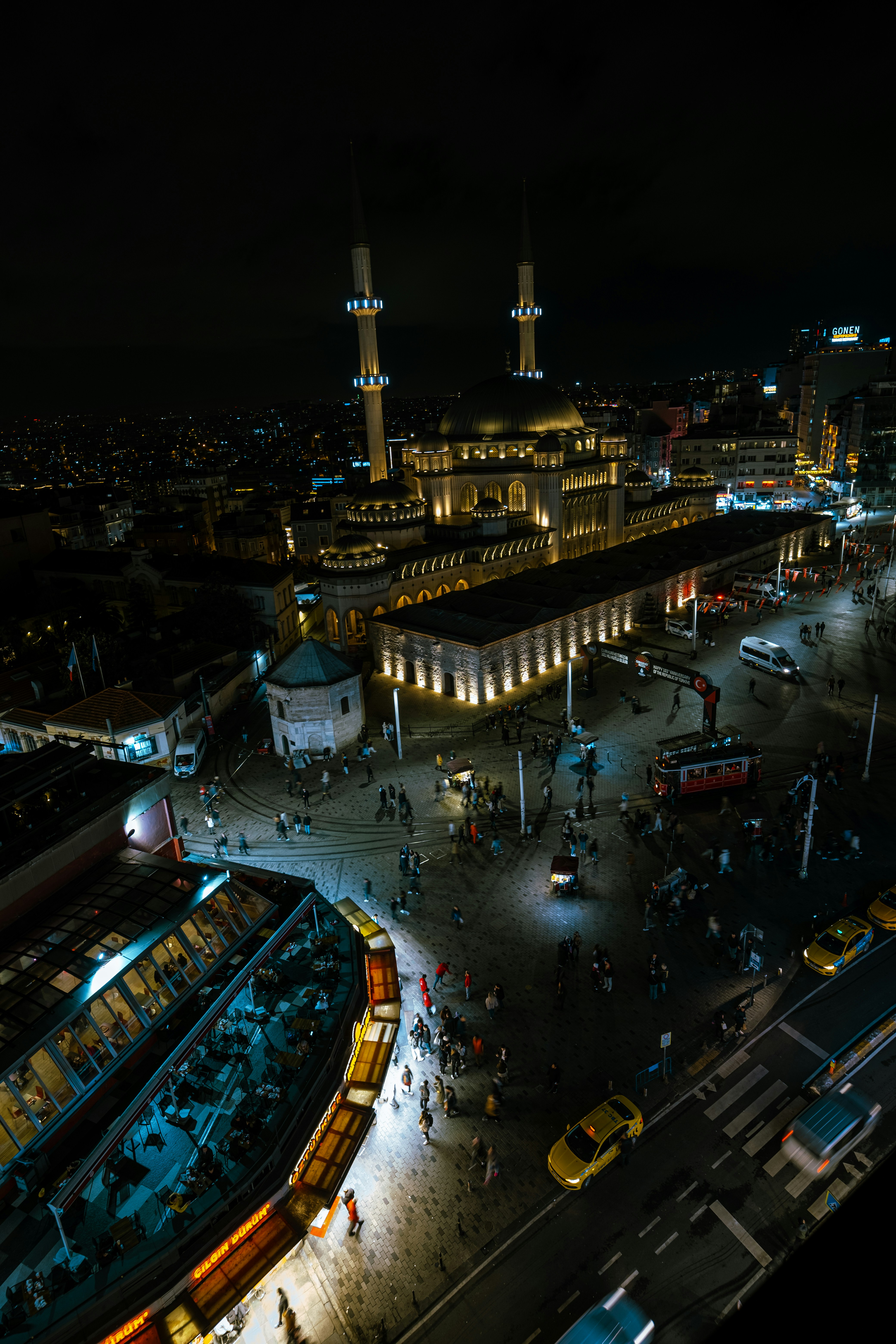 Midnight Lanterns: The Twin-Minaret Mosque Anchoring a Bustling City Square