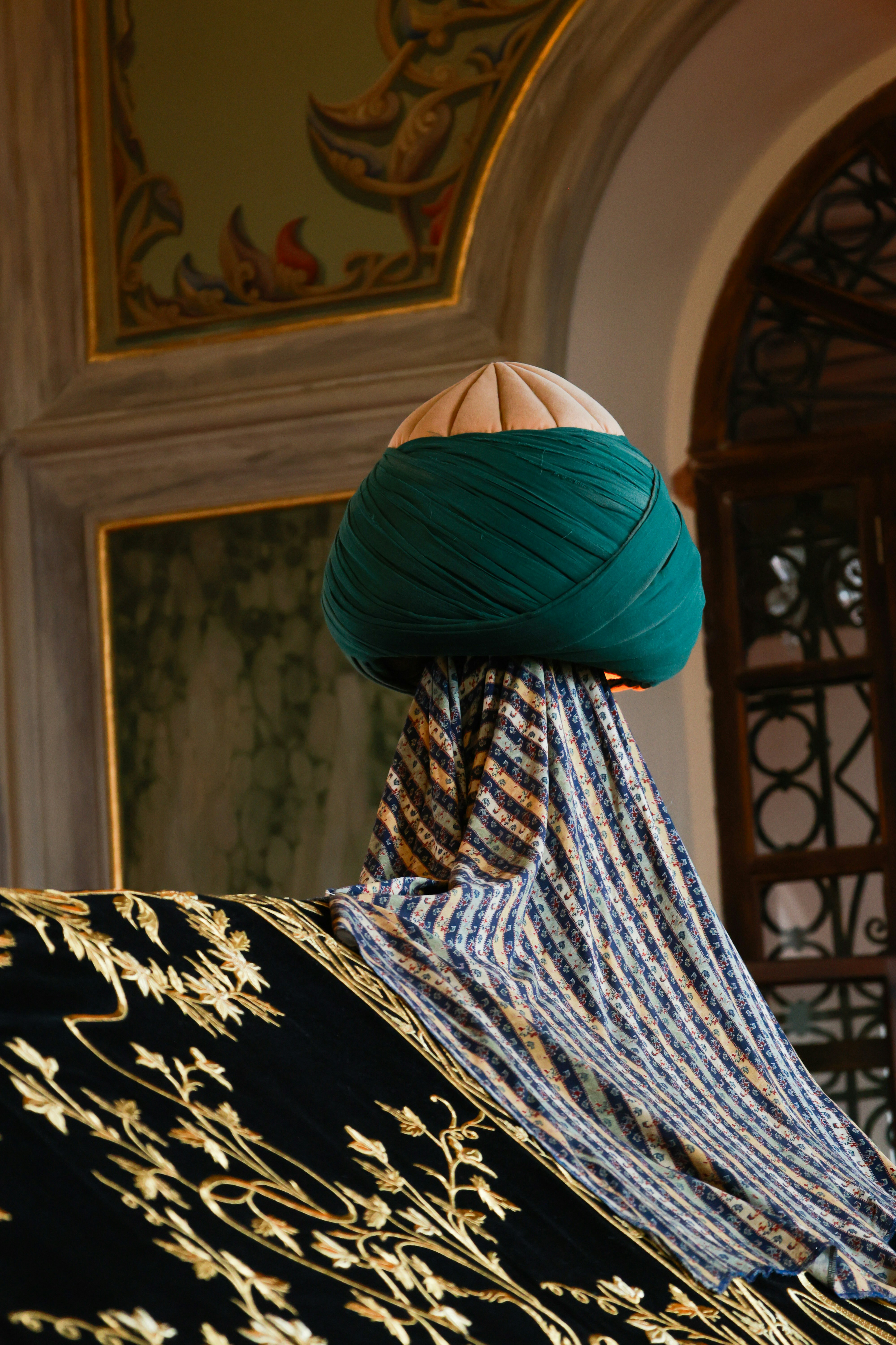 A woman with a green turban on her head