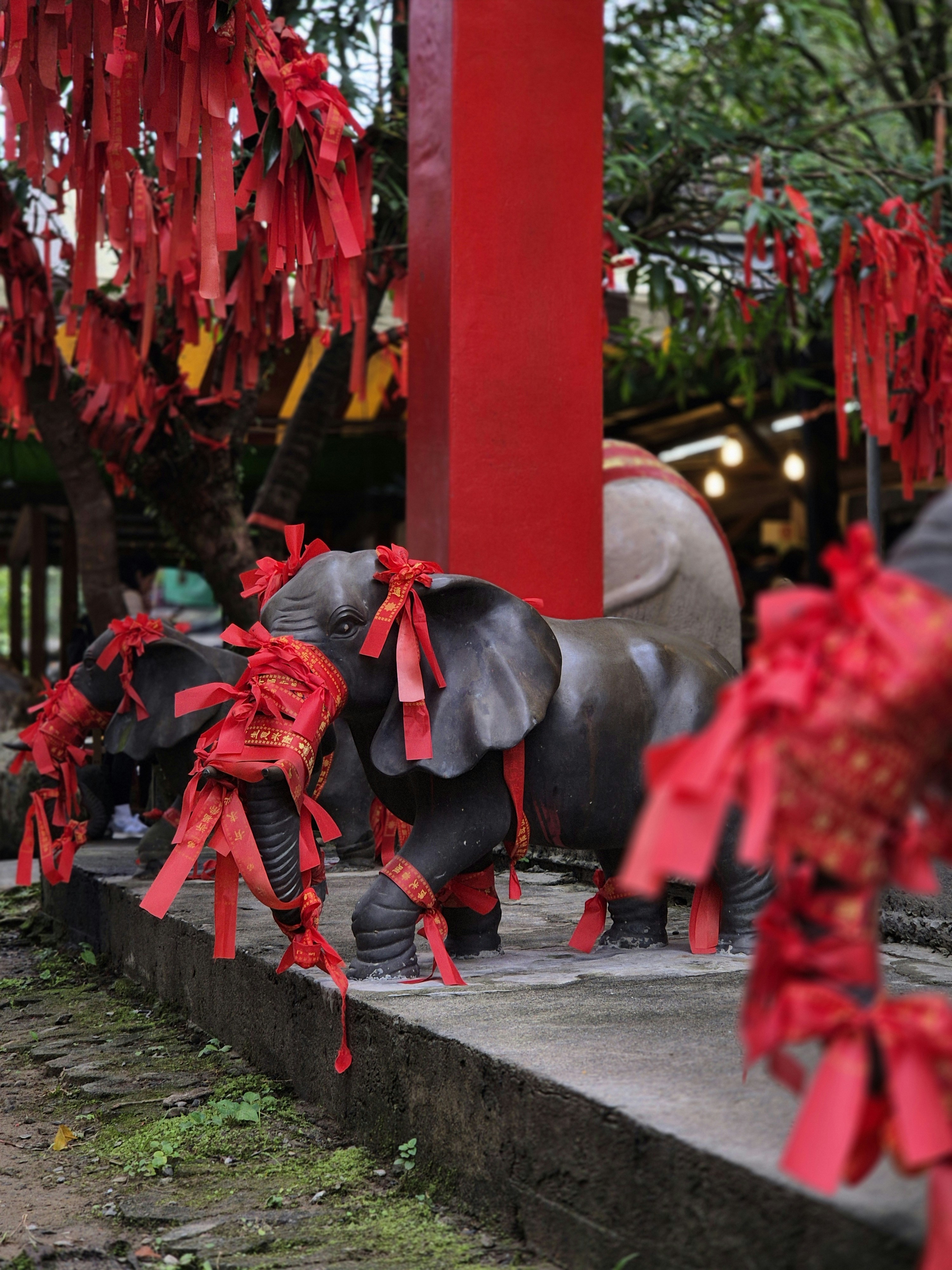 Red Ribboned Elephants at a Shrine Gate