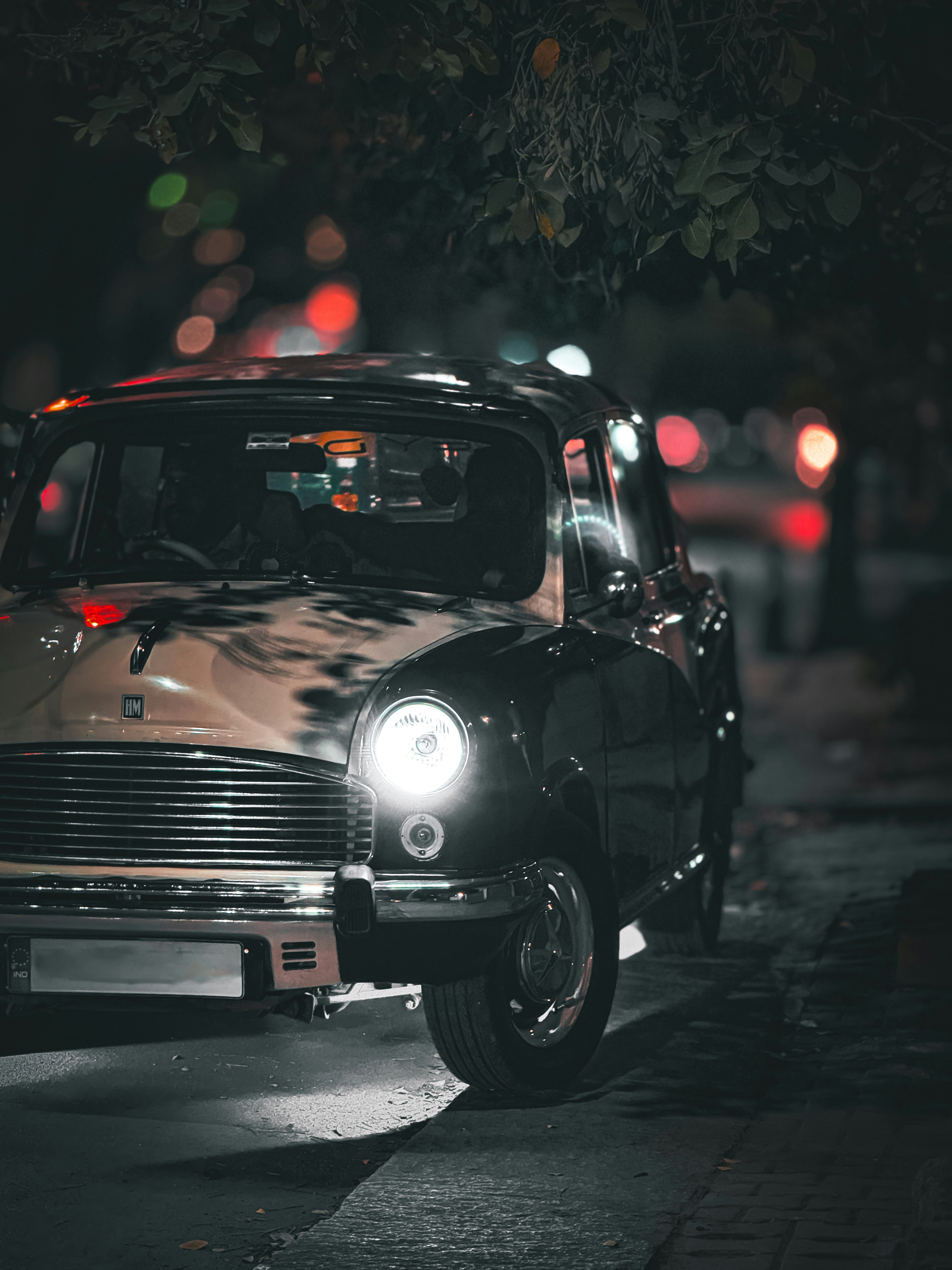 Chrome and Halo: A Vintage Sedan Glowing Under City Night