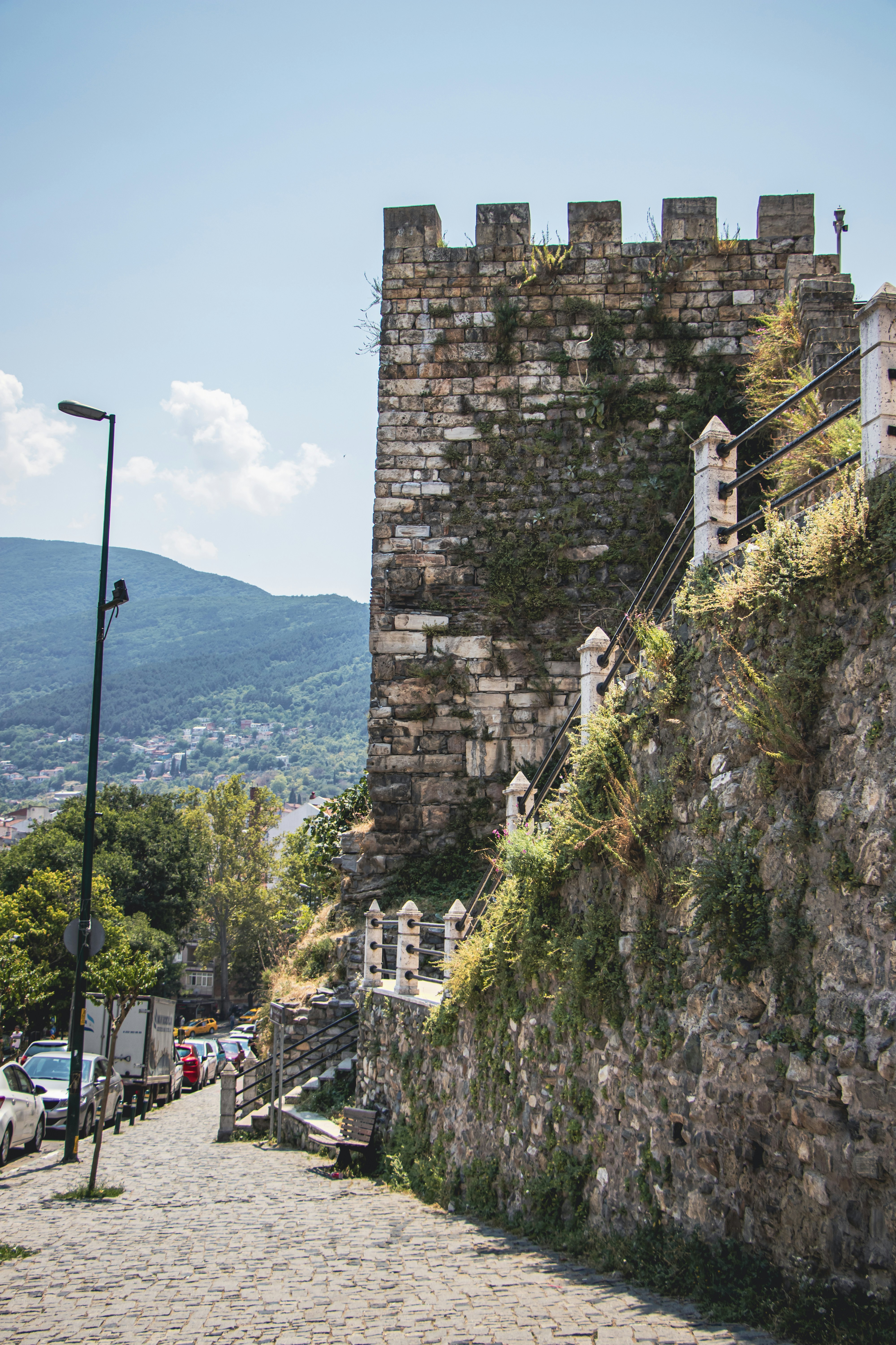 Street on the Forward Castle Wall: Cobblestones, Guarded Path, and Steep Stone Ramparts