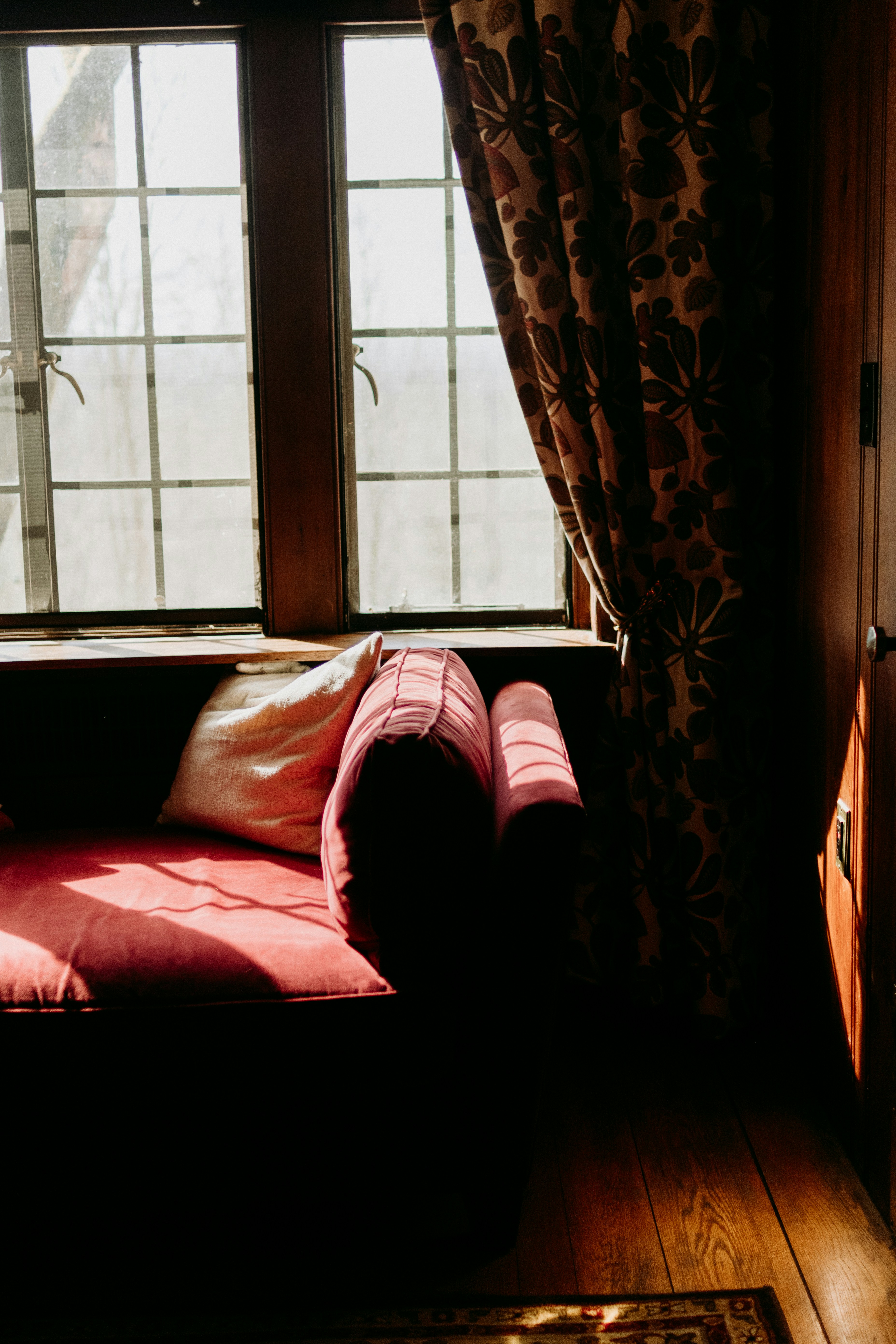 A couch sitting in front of a window in a living room photo – Free ...