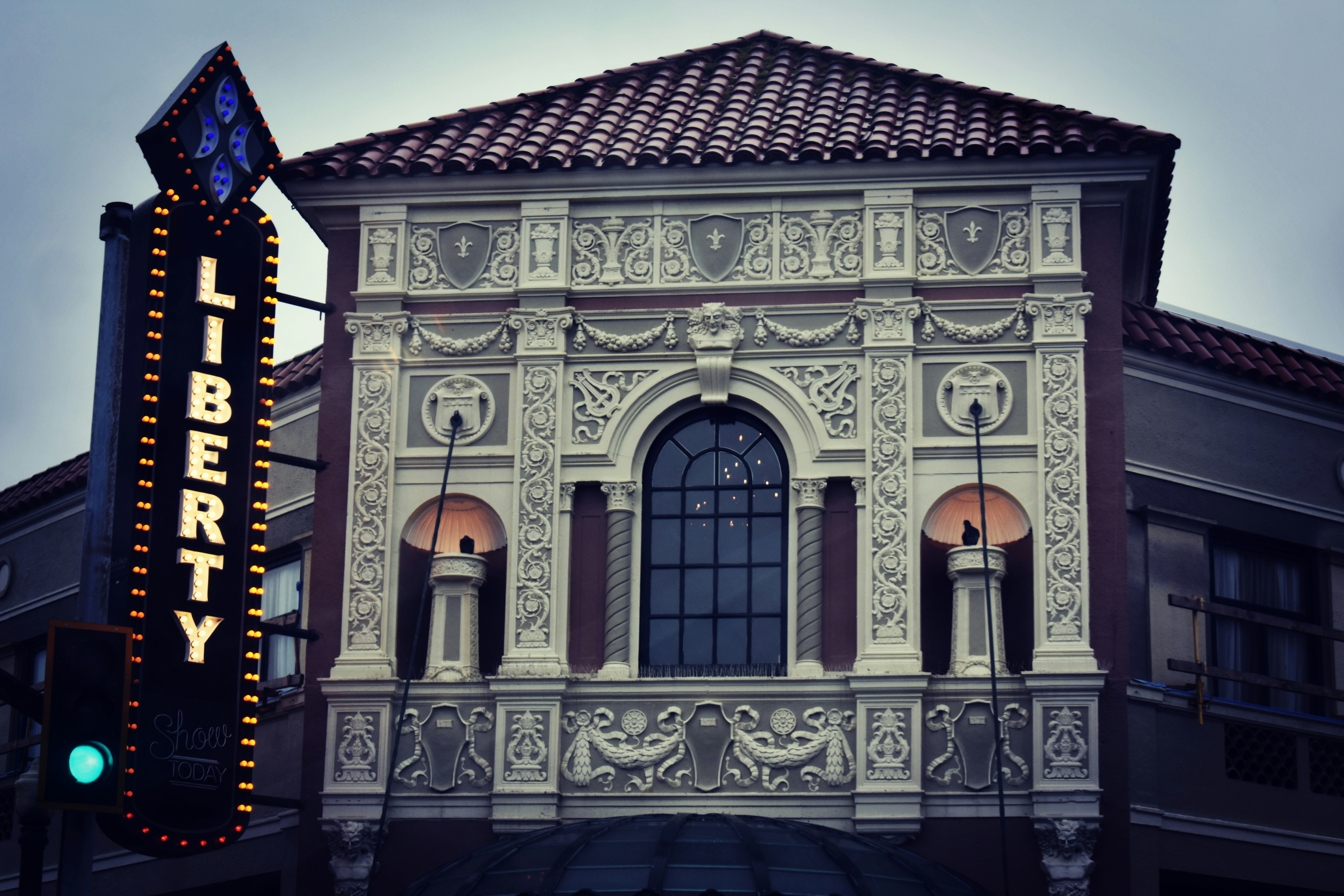 Historic theater with intricate architectural details and illuminated marquee.