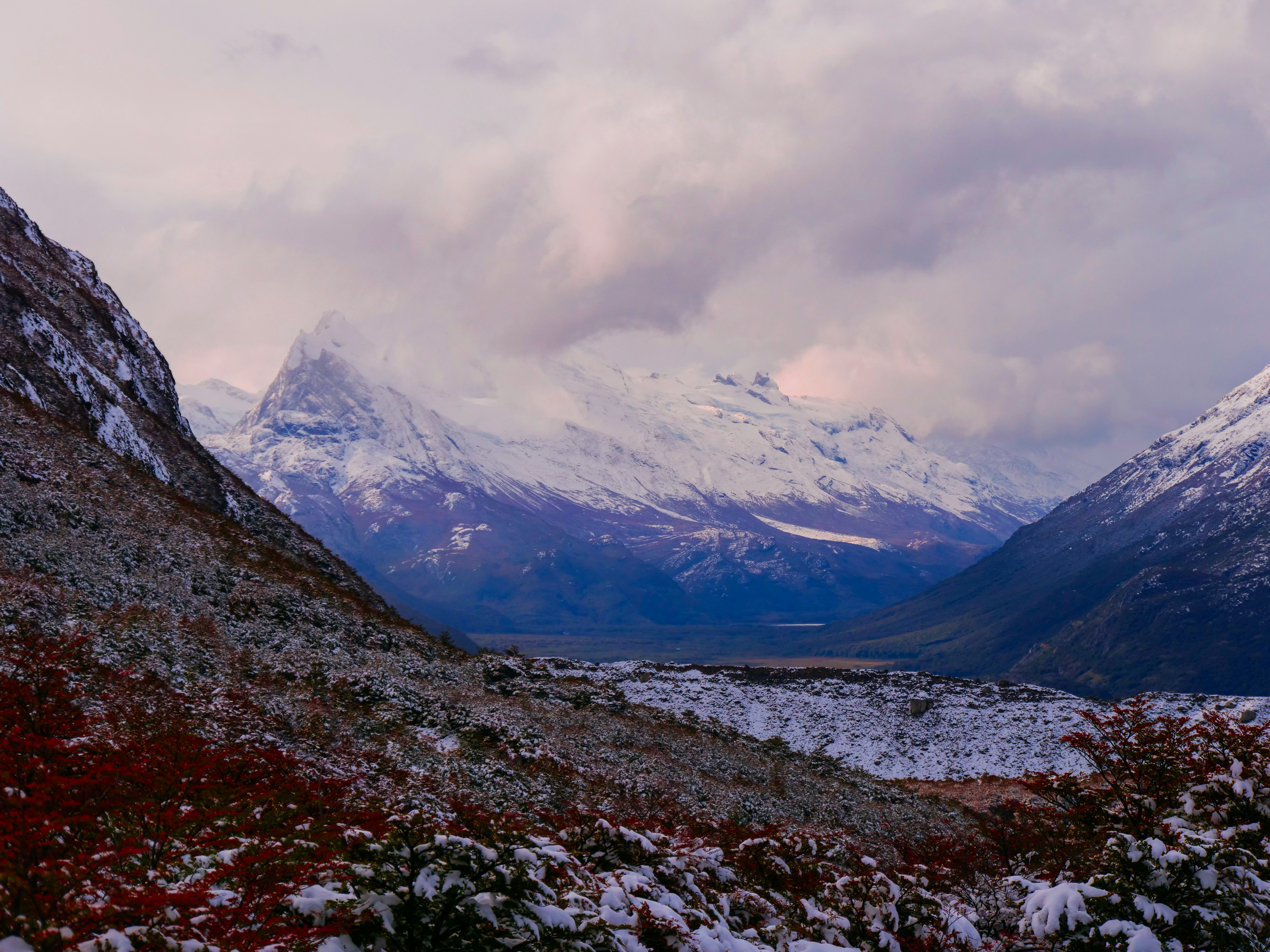 Crimson Hues in a Snowy Mountain Pass