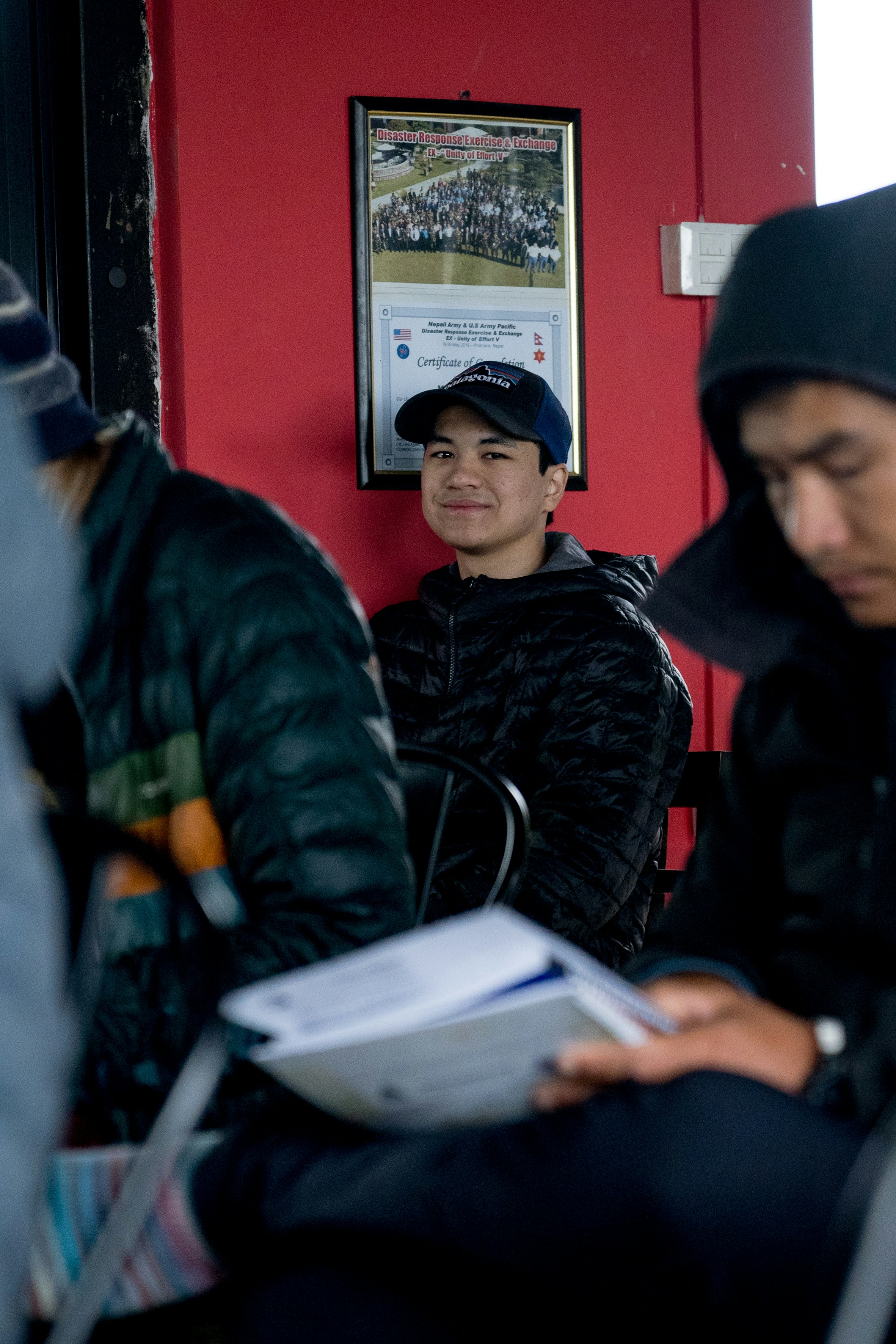 A group of people sitting next to each other photo – Free Cap Image on ...