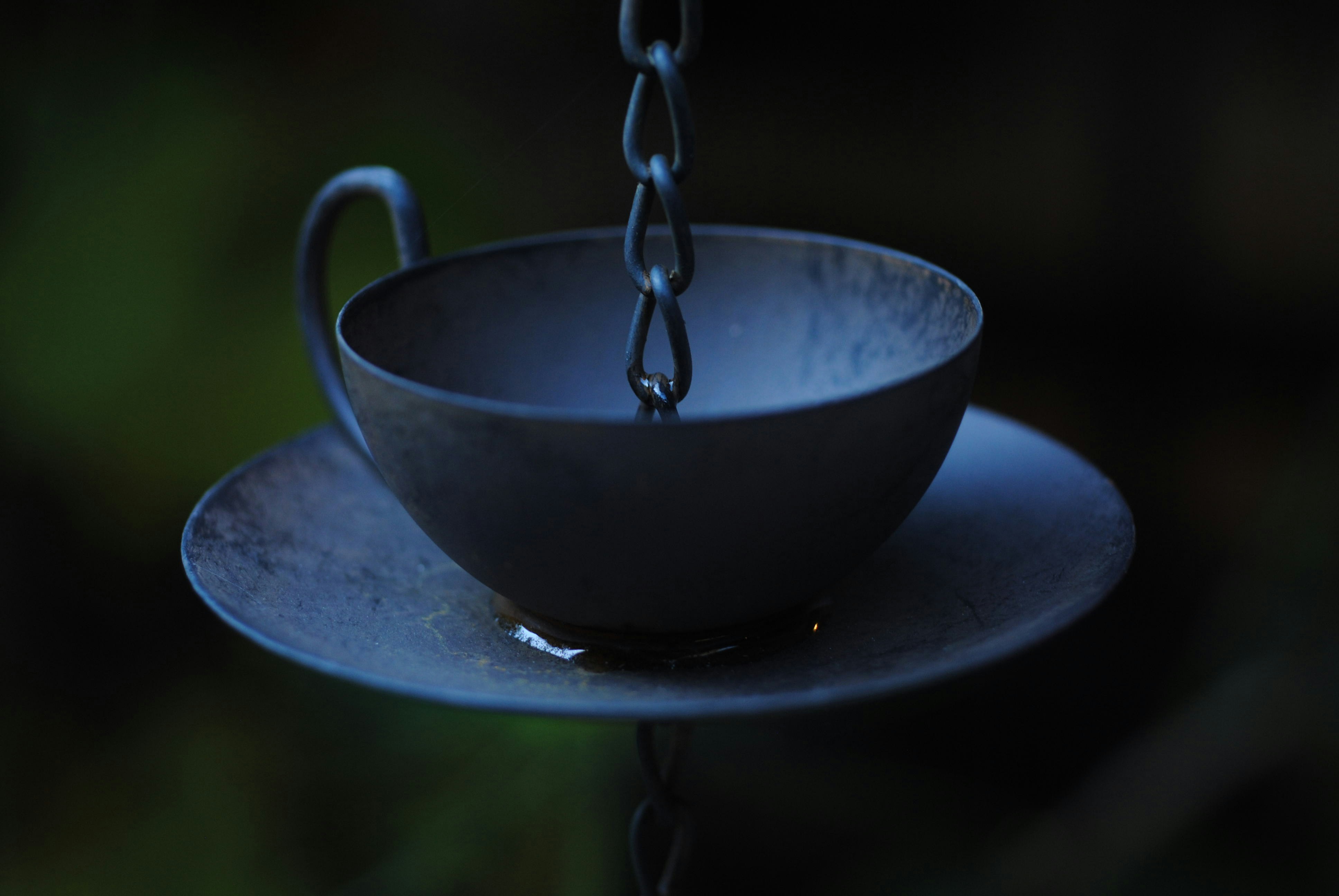 Midnight Blue: A Cup on a Chain Suspended in Soft Focus