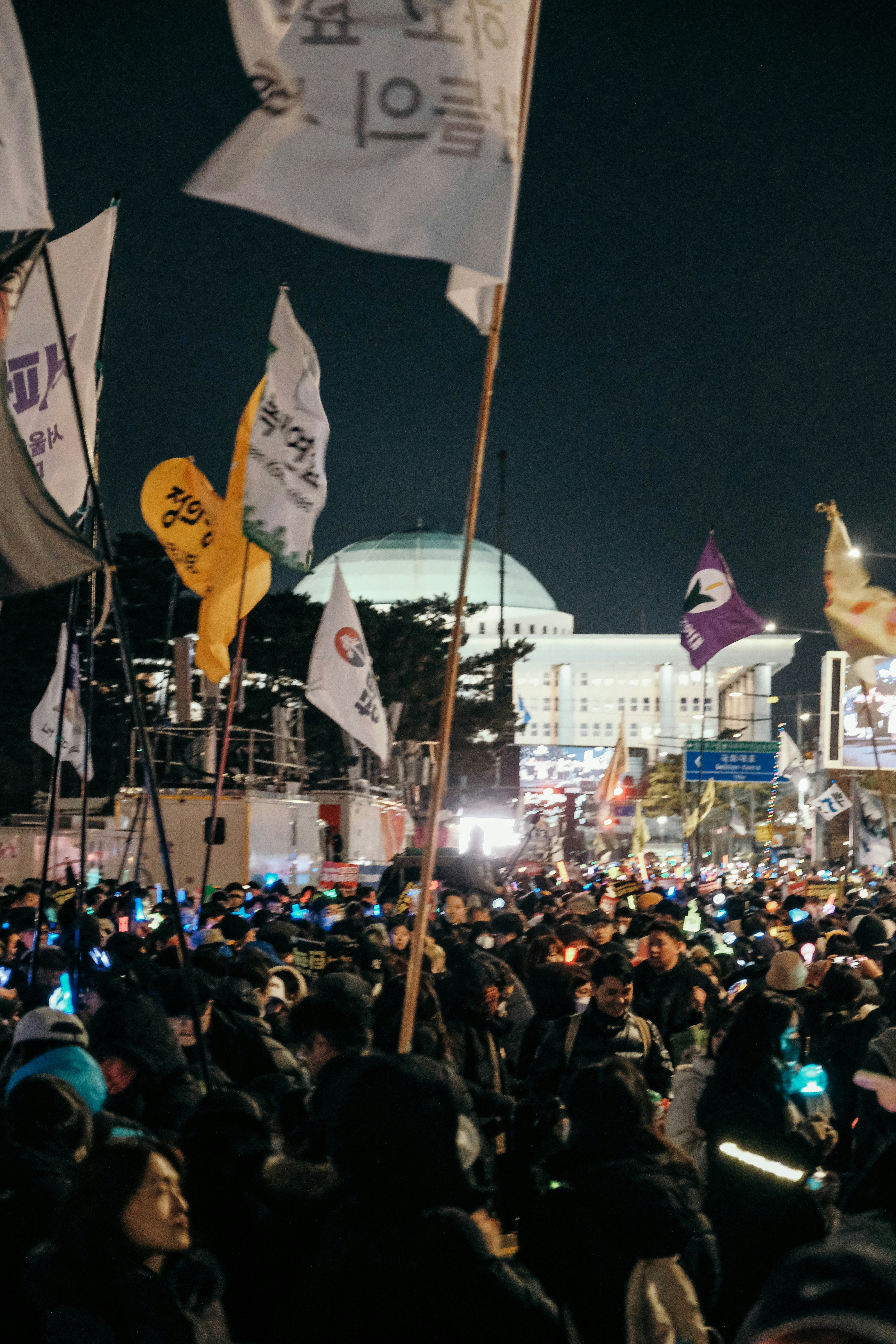 A large crowd of people holding flags and cell phones photo – Free ...