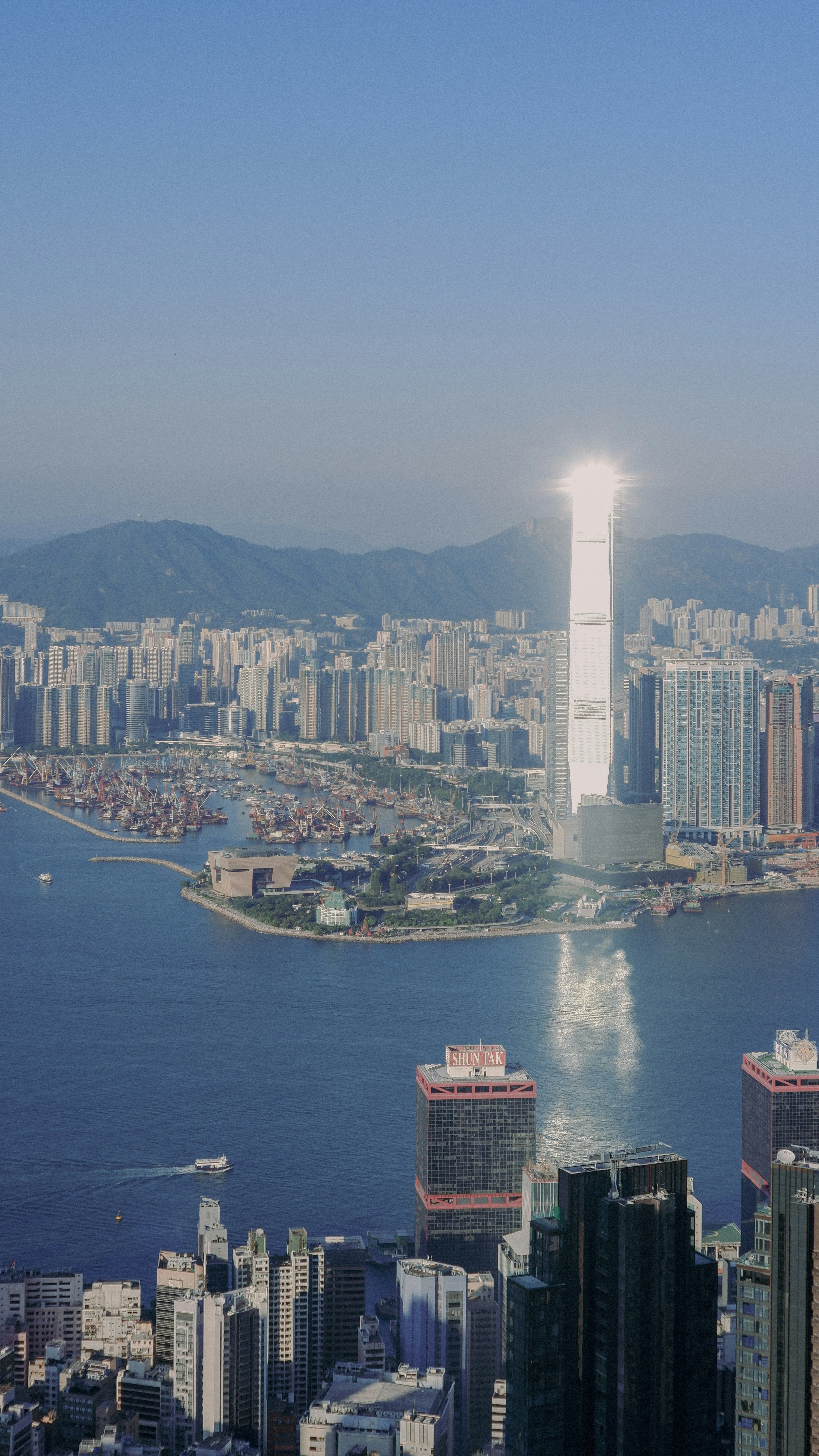 Sunlit Harbor Tower: A Vertical Cityscape Embraced by Light
