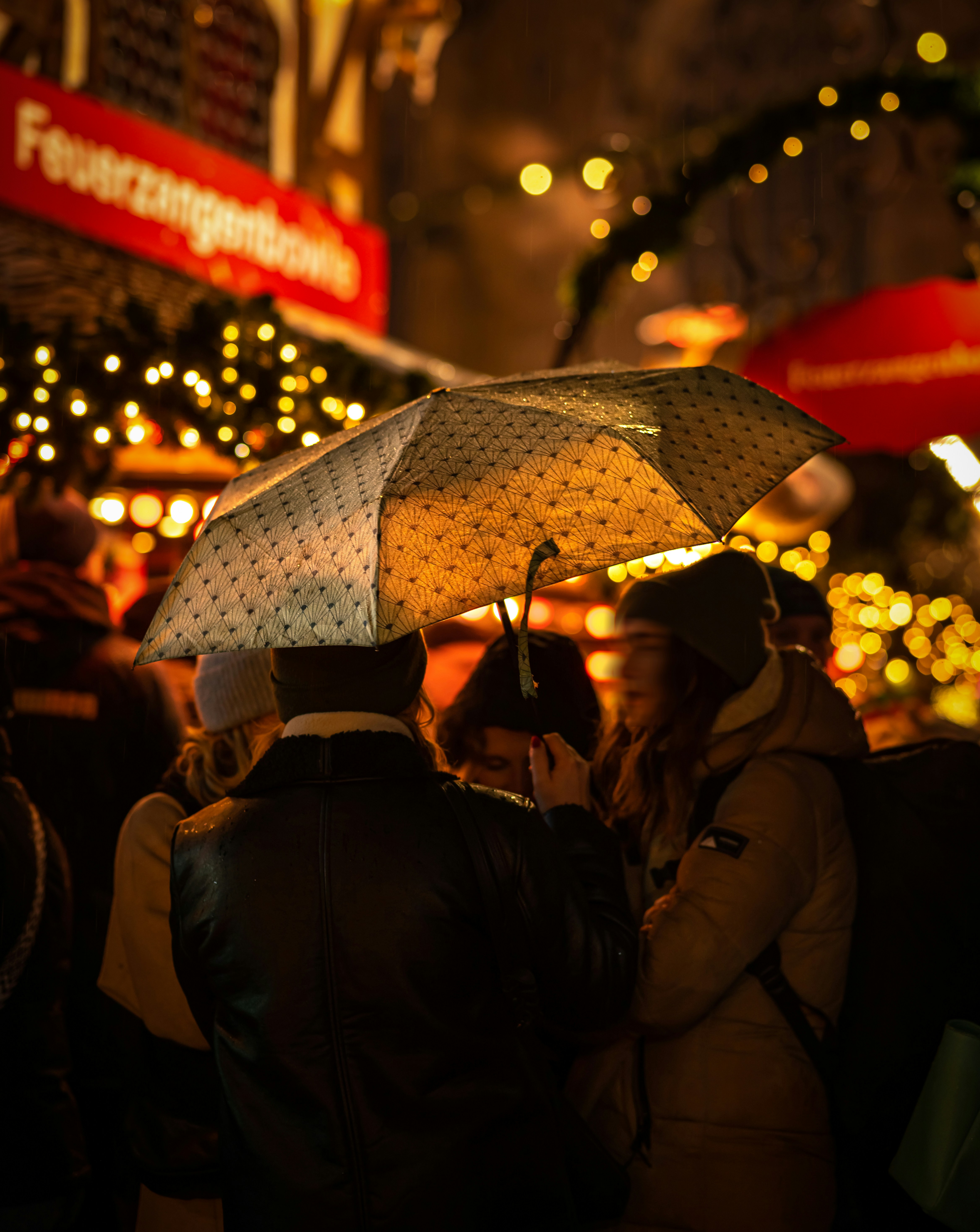 Dotted Umbrella Amid Winter Market Lights