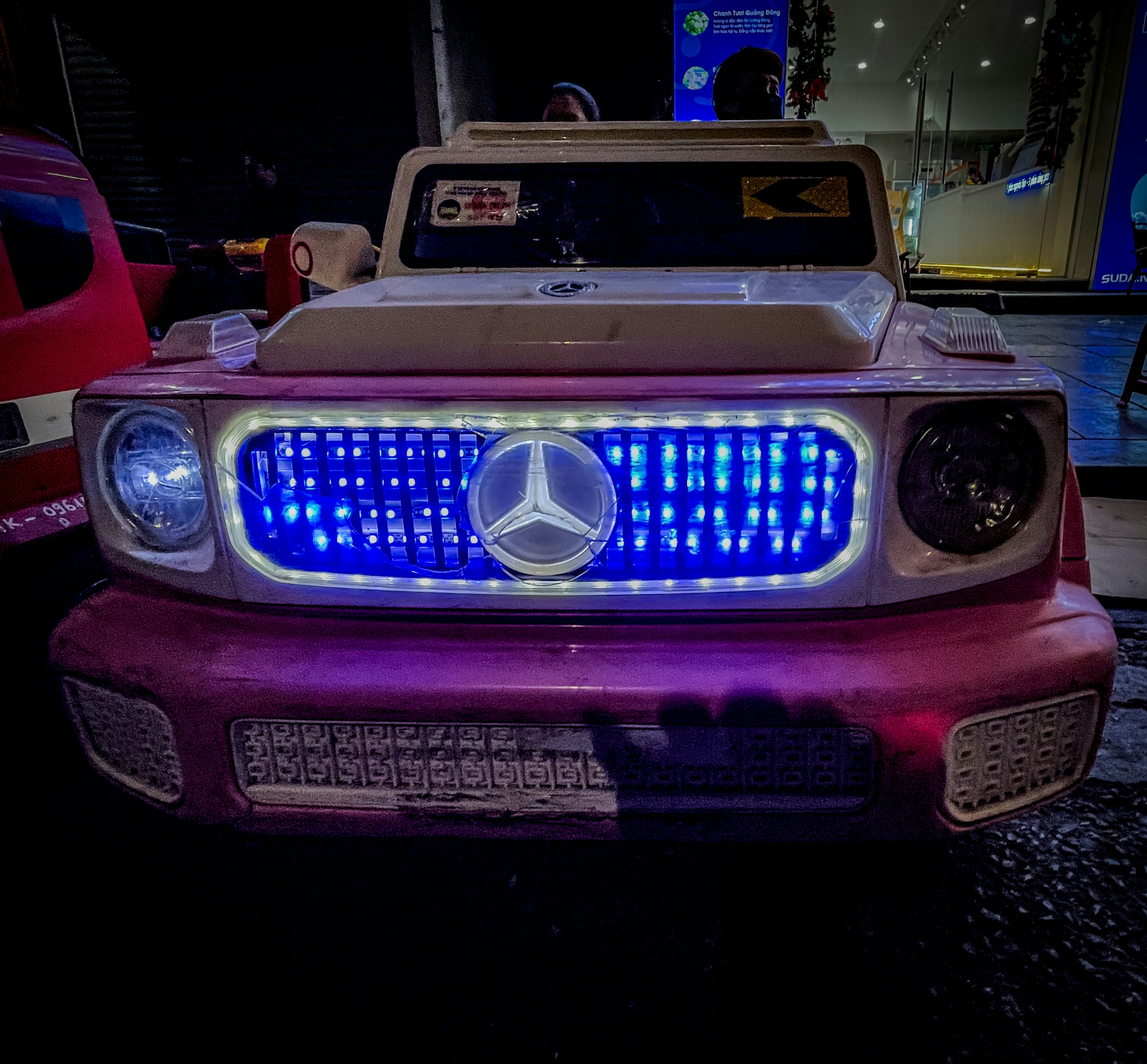 Neon Grille: A Mercedes-Benz Truck's Night Parade