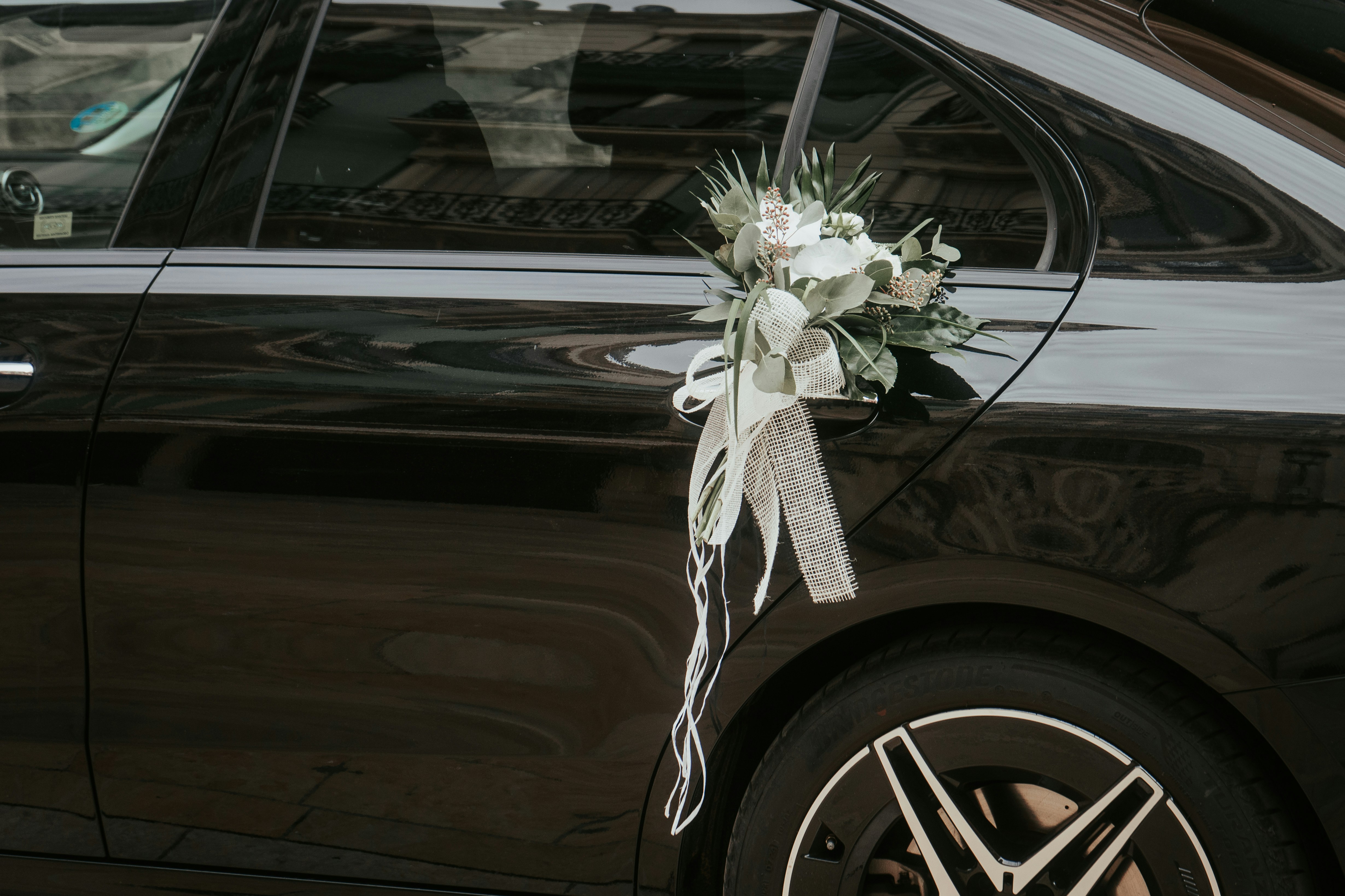Ribboned Bouquet Adorns a Black Wedding Car Door