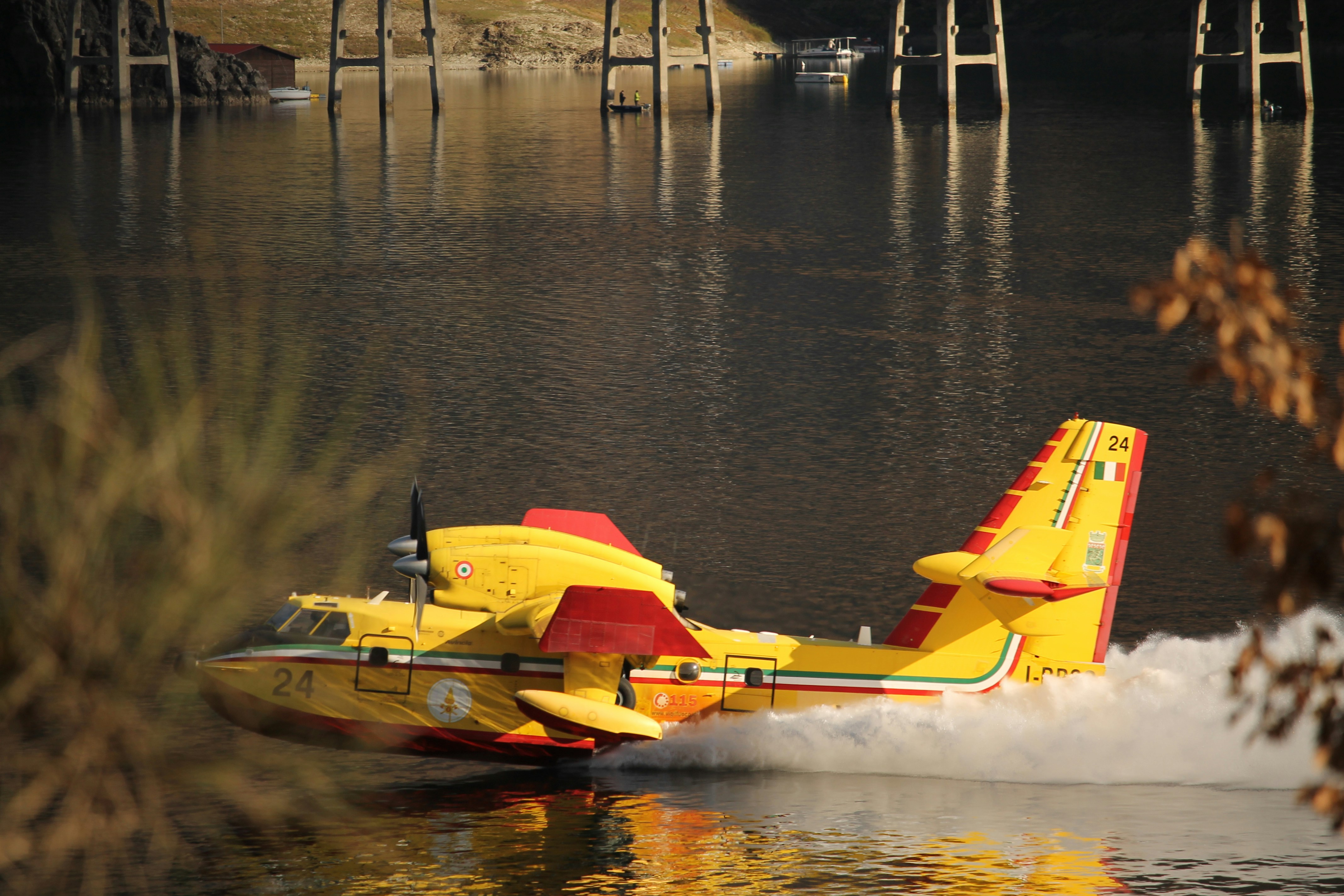A yellow and red plane is in the water photo – Free Lake Image on Unsplash