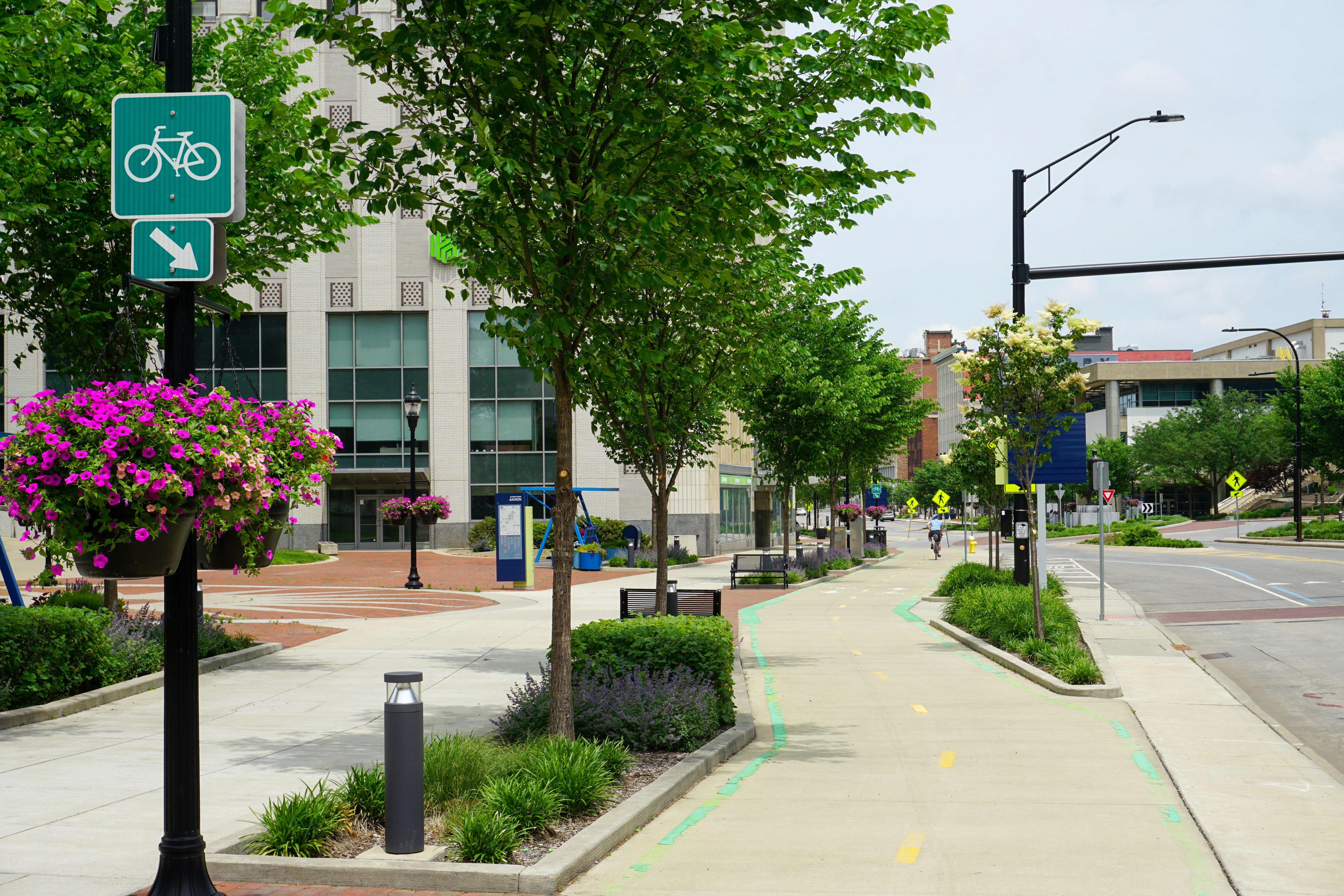 A city street with a bicycle sign on the side of it photo – Free Akron ...