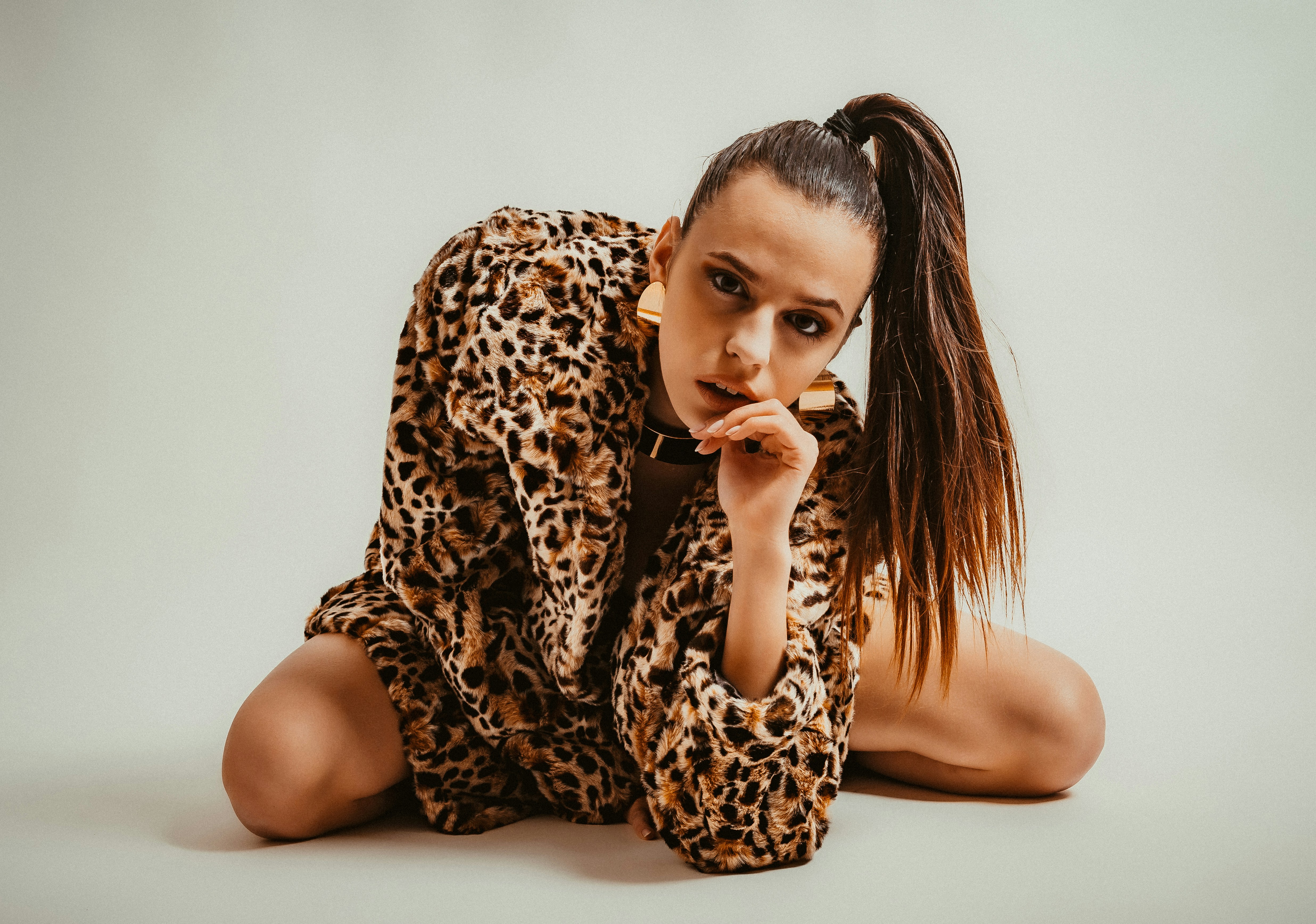 Leopard print and porcelain gaze: a poised studio portrait