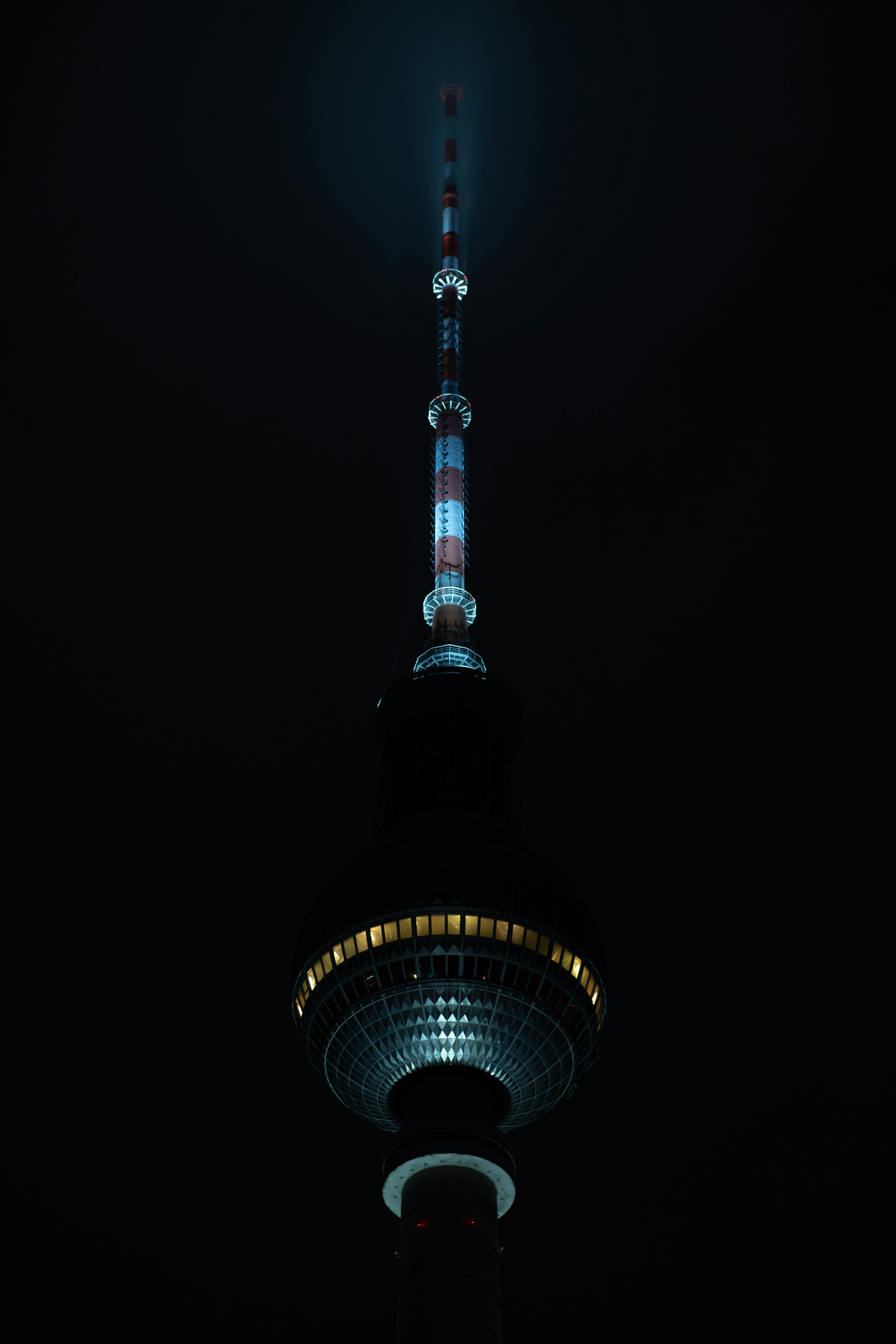 A very tall building with a very bright light on top of it photo – Free ...