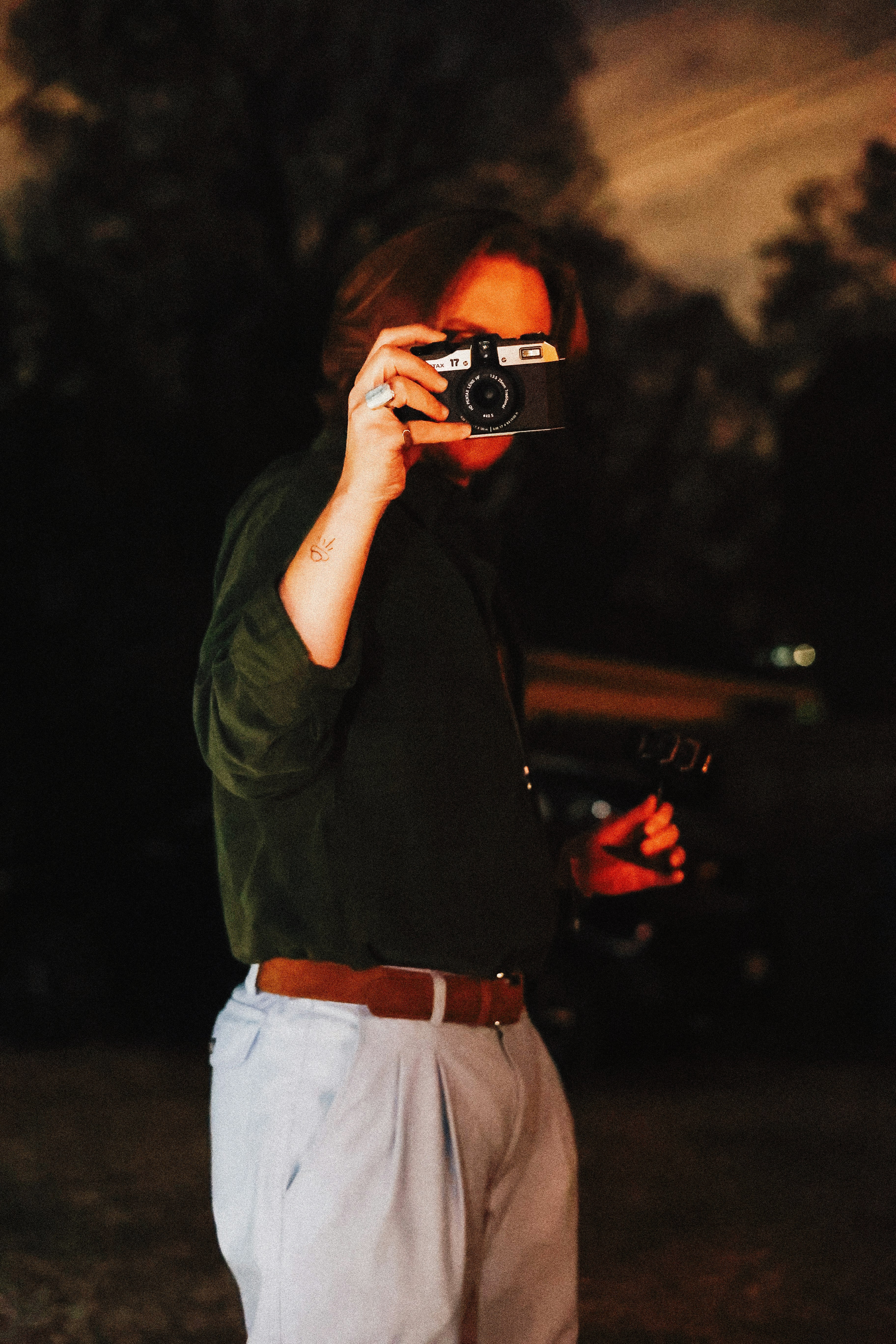 Man at a Christmas party with champagne and a film camera