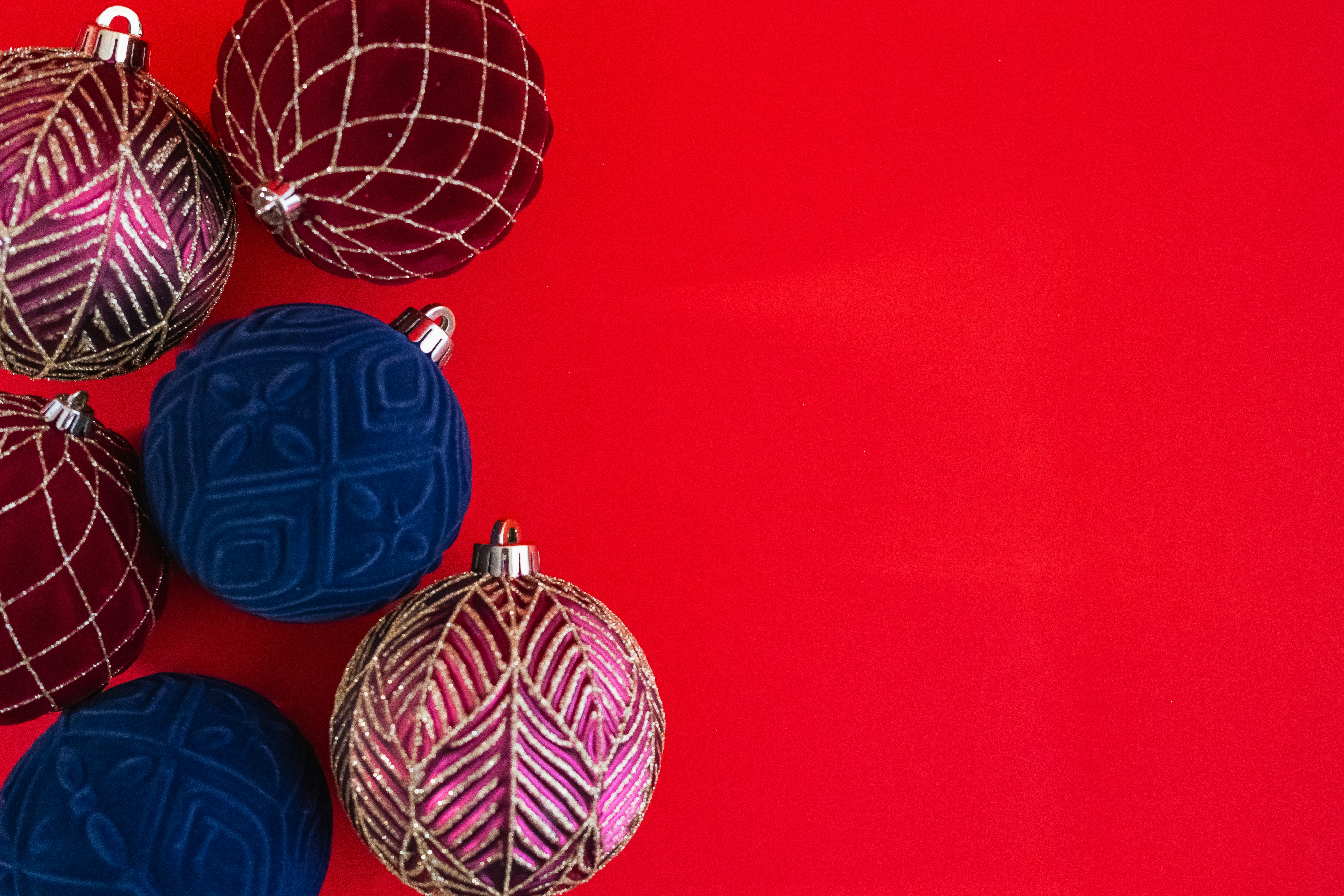 Velvet Ornaments Nestled Against a Scarlet Canvas
