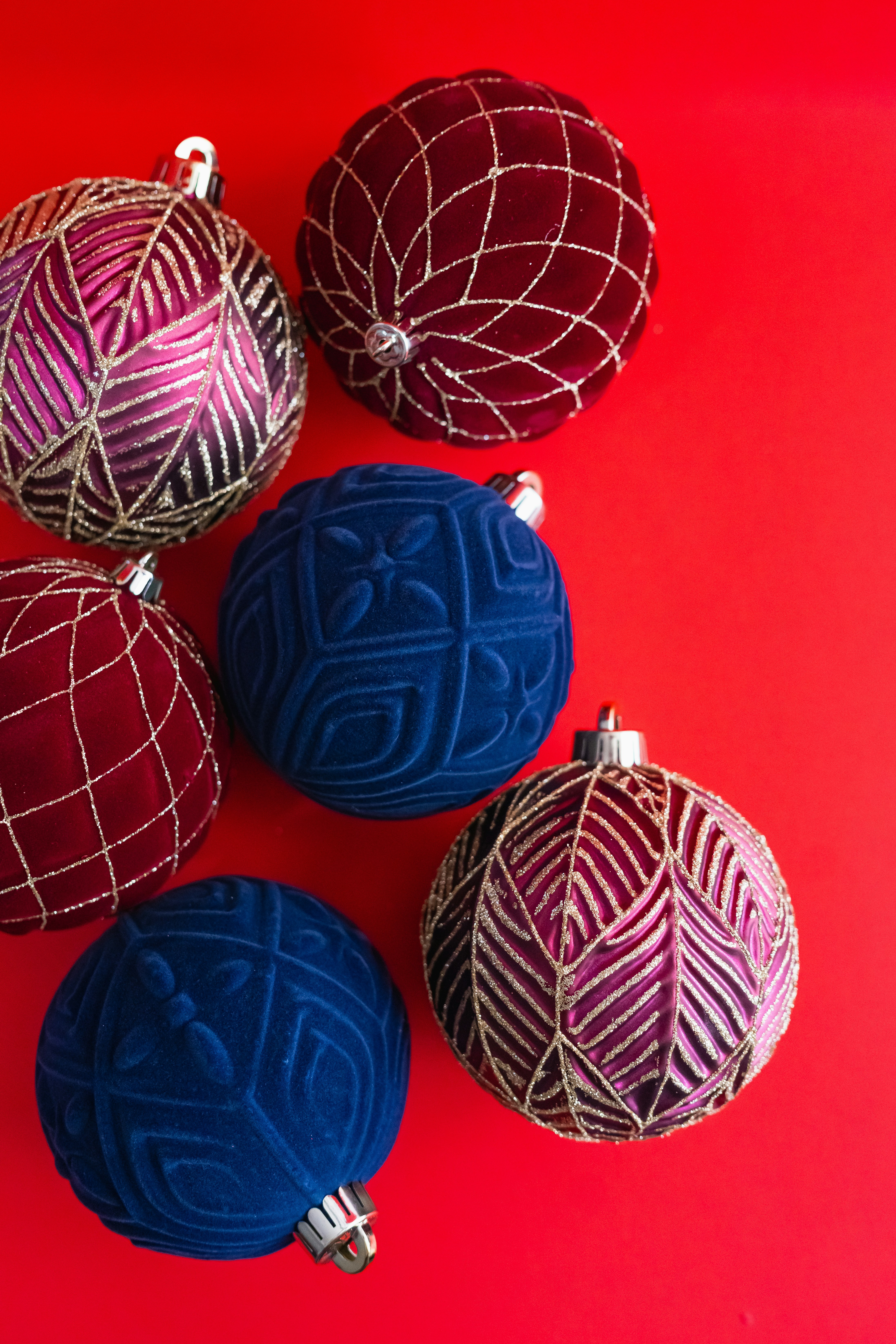 Crimson Velvet Ornaments: A Glittering Cluster on Red Canvas