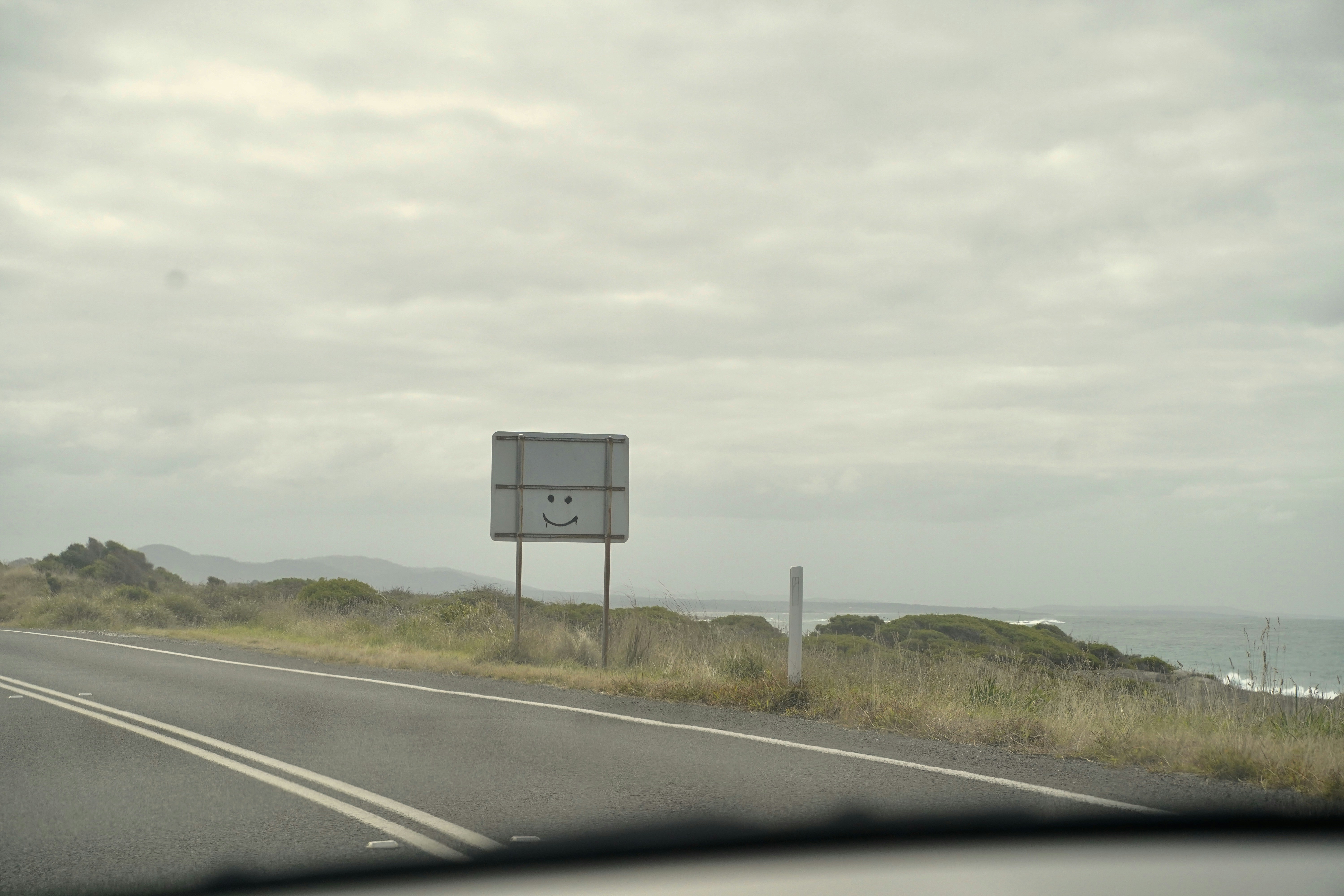 smiley face on a traffic road sign