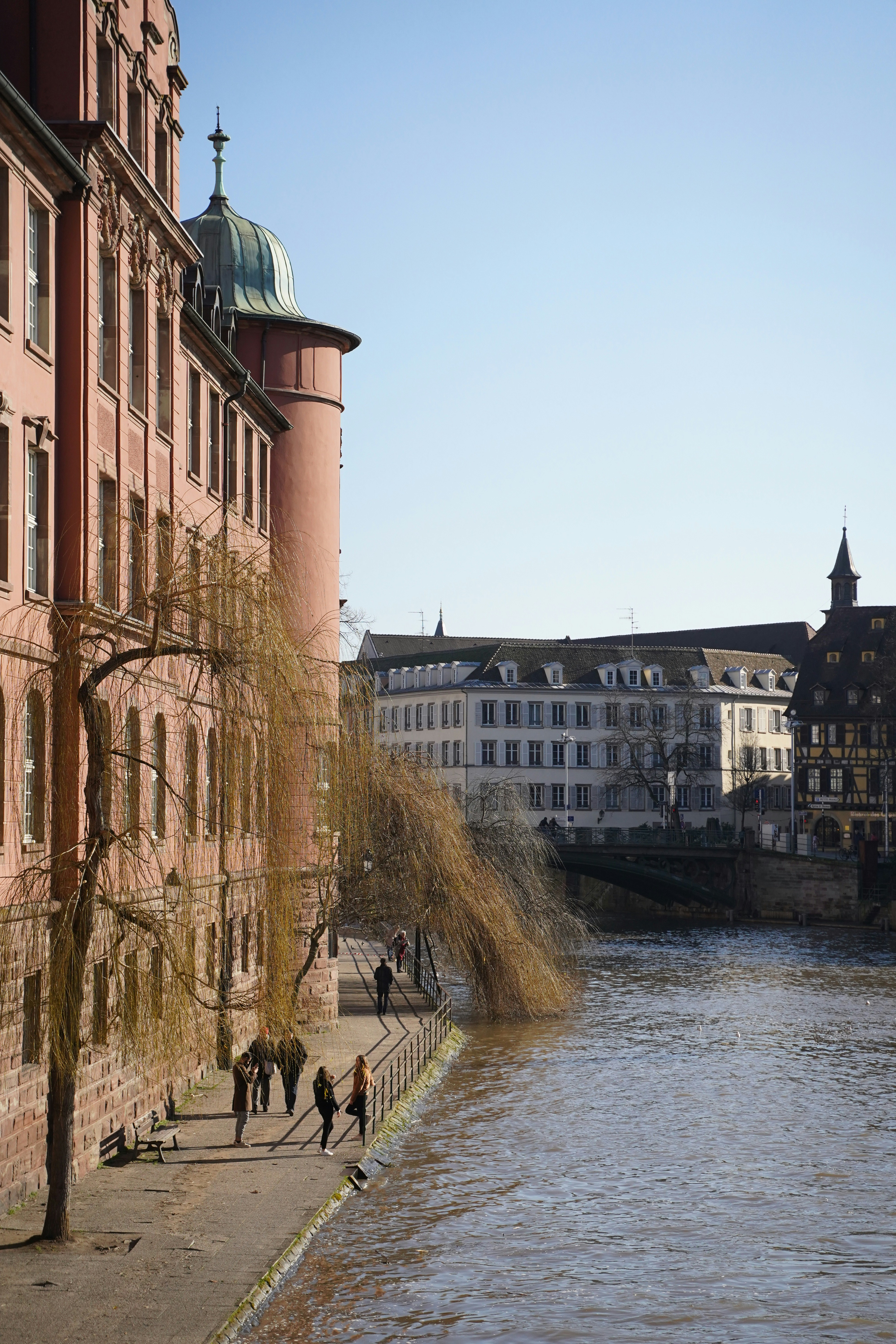 Turreted Brick by the River: A Quiet Promenade in a Historic Quarter