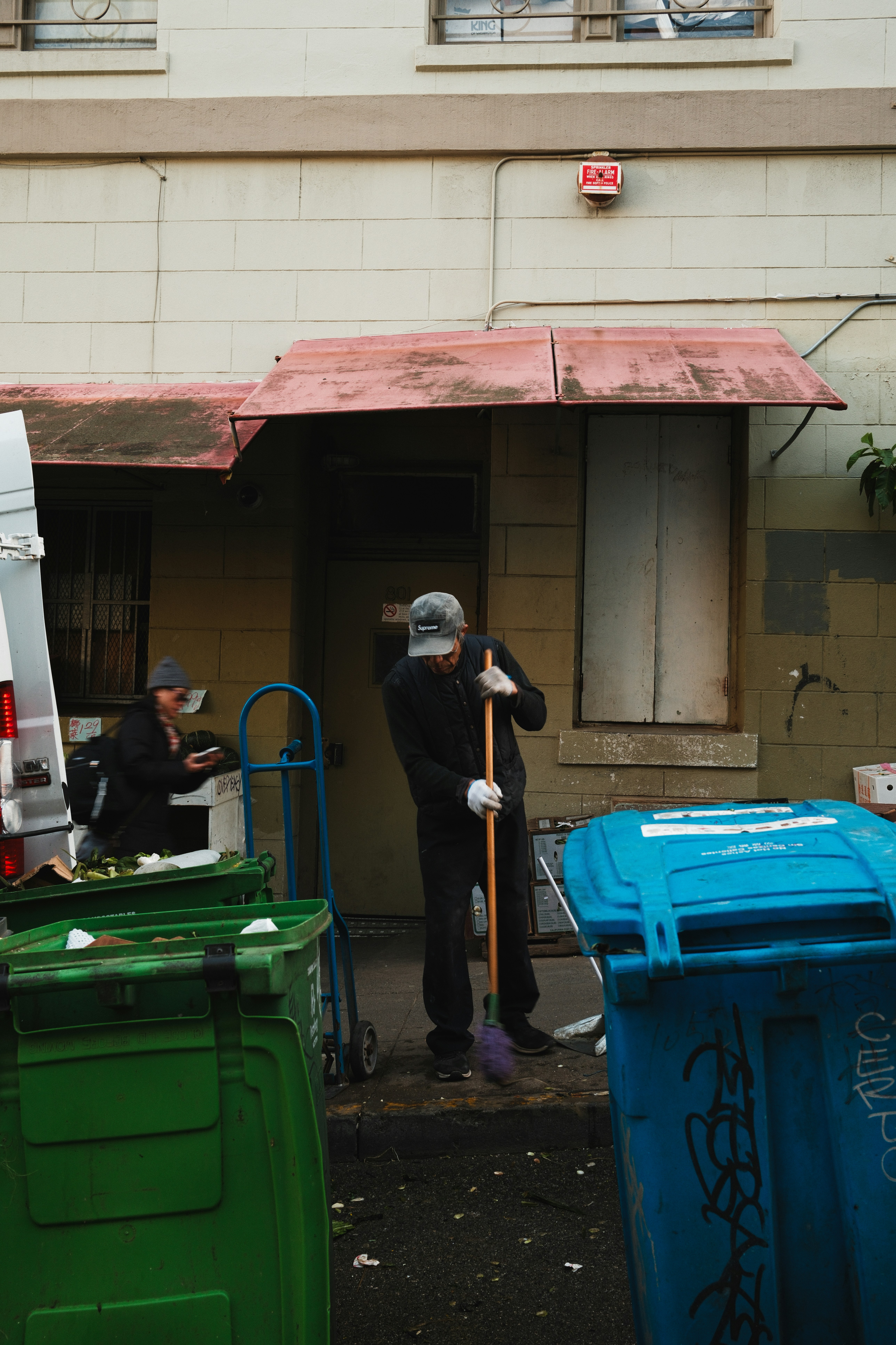 A group of garbage cans sitting in front of a building photo – Free San ...