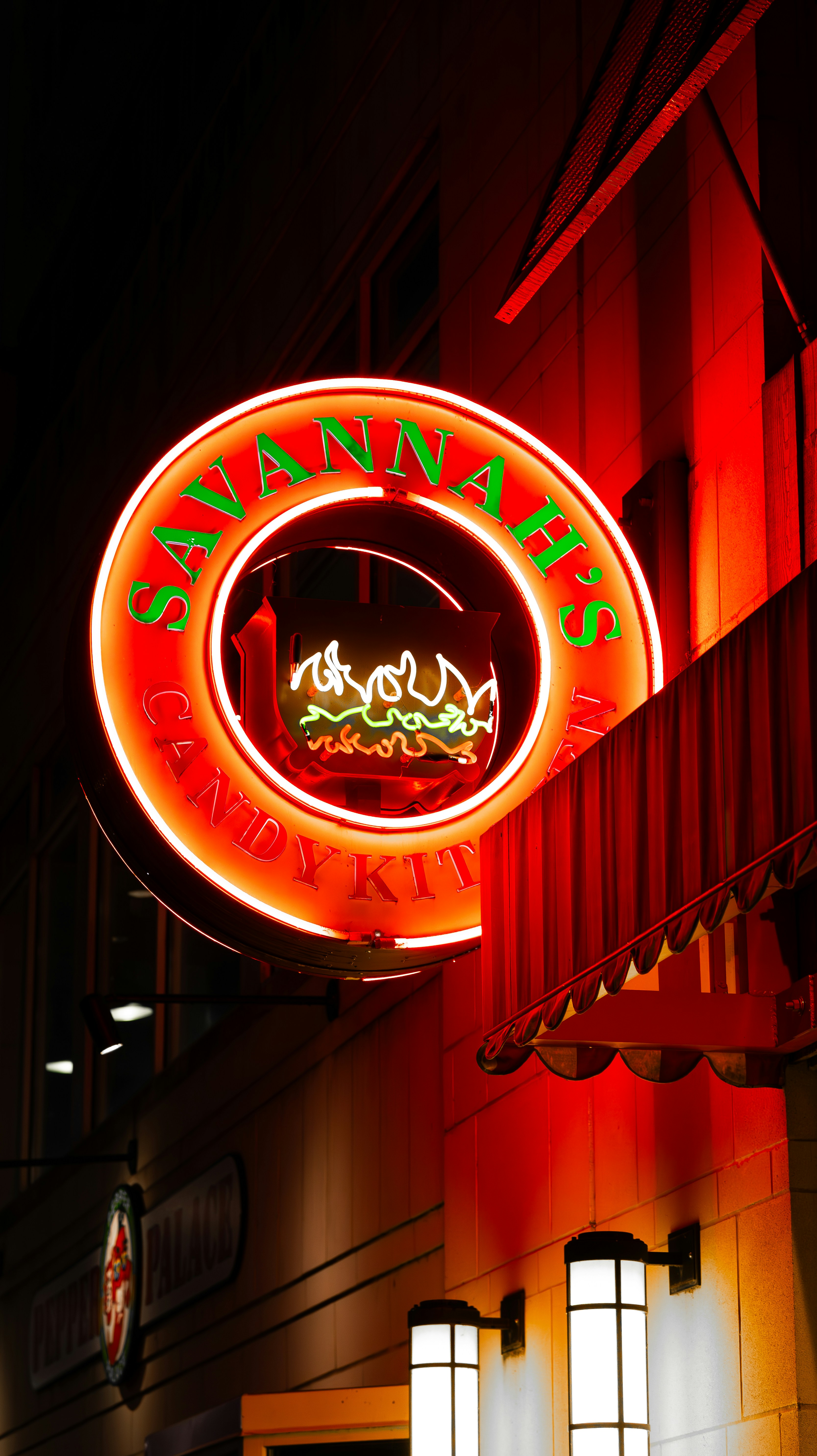 A neon sign hanging from the side of a building photo – Free Restaurant ...