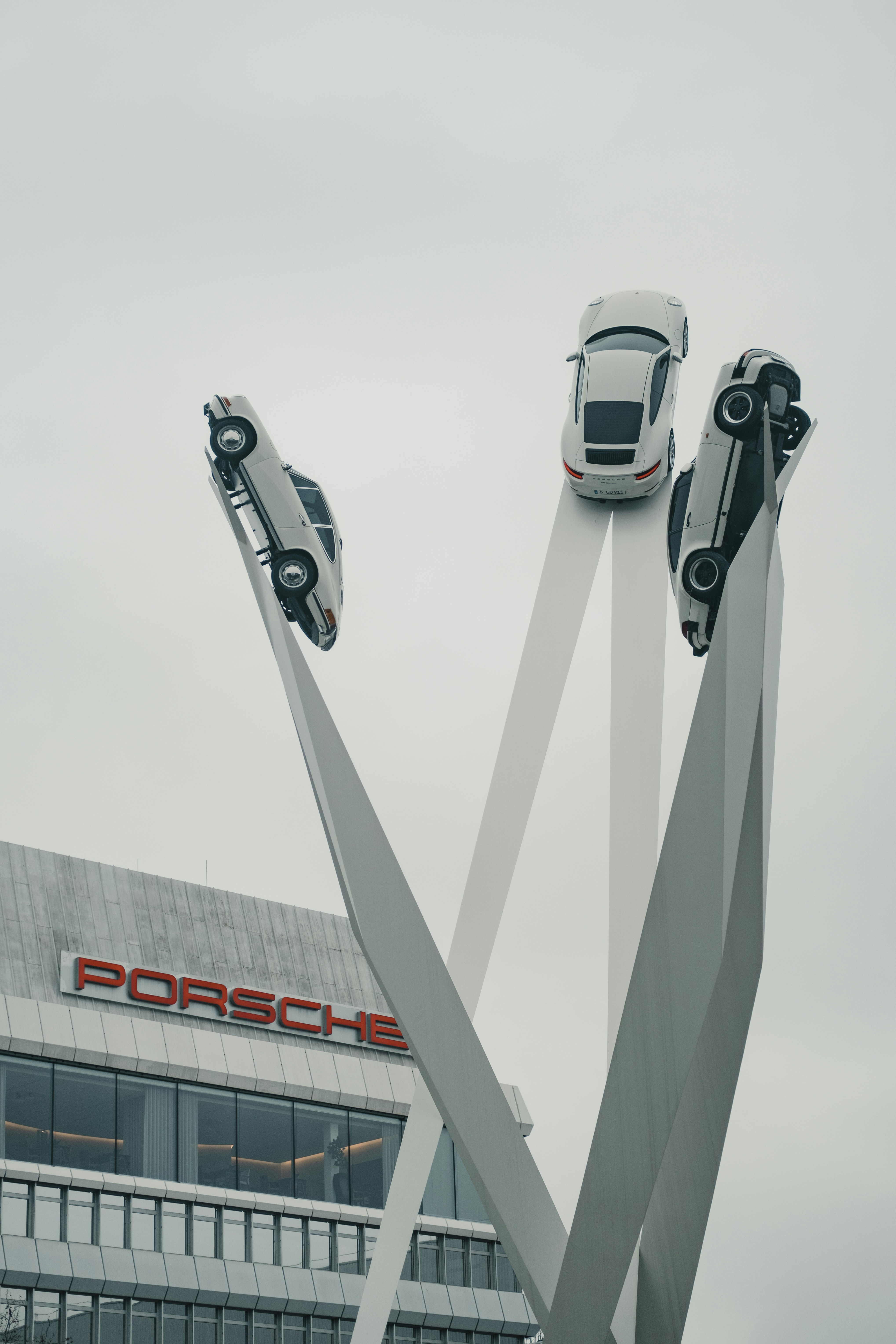 Porsche Ascension: Three Metal Arches Elevate Cars into the Overcast Sky
