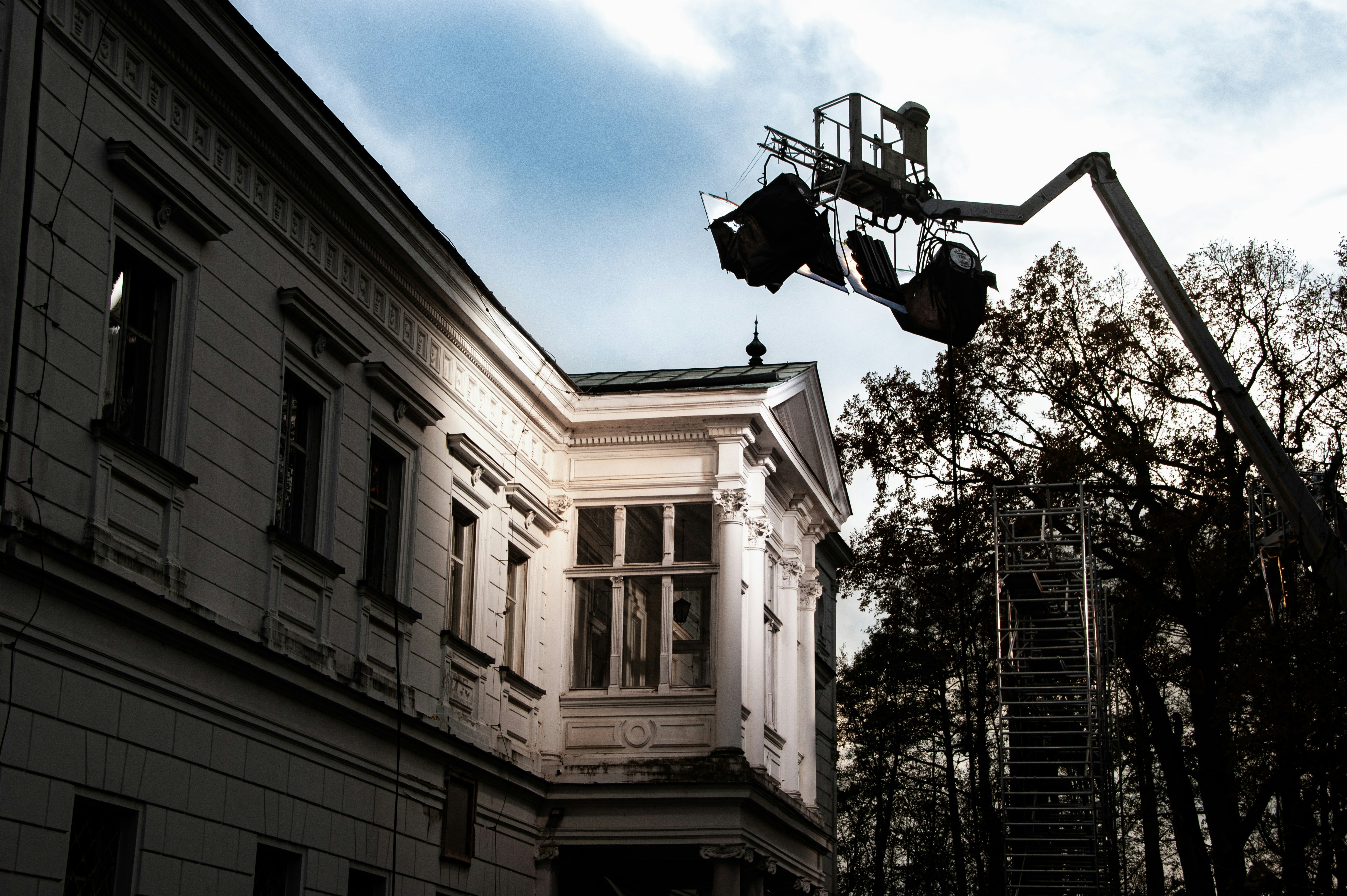 Twilight Lift Over a Classical Corner: Crane Above the Heritage Facade