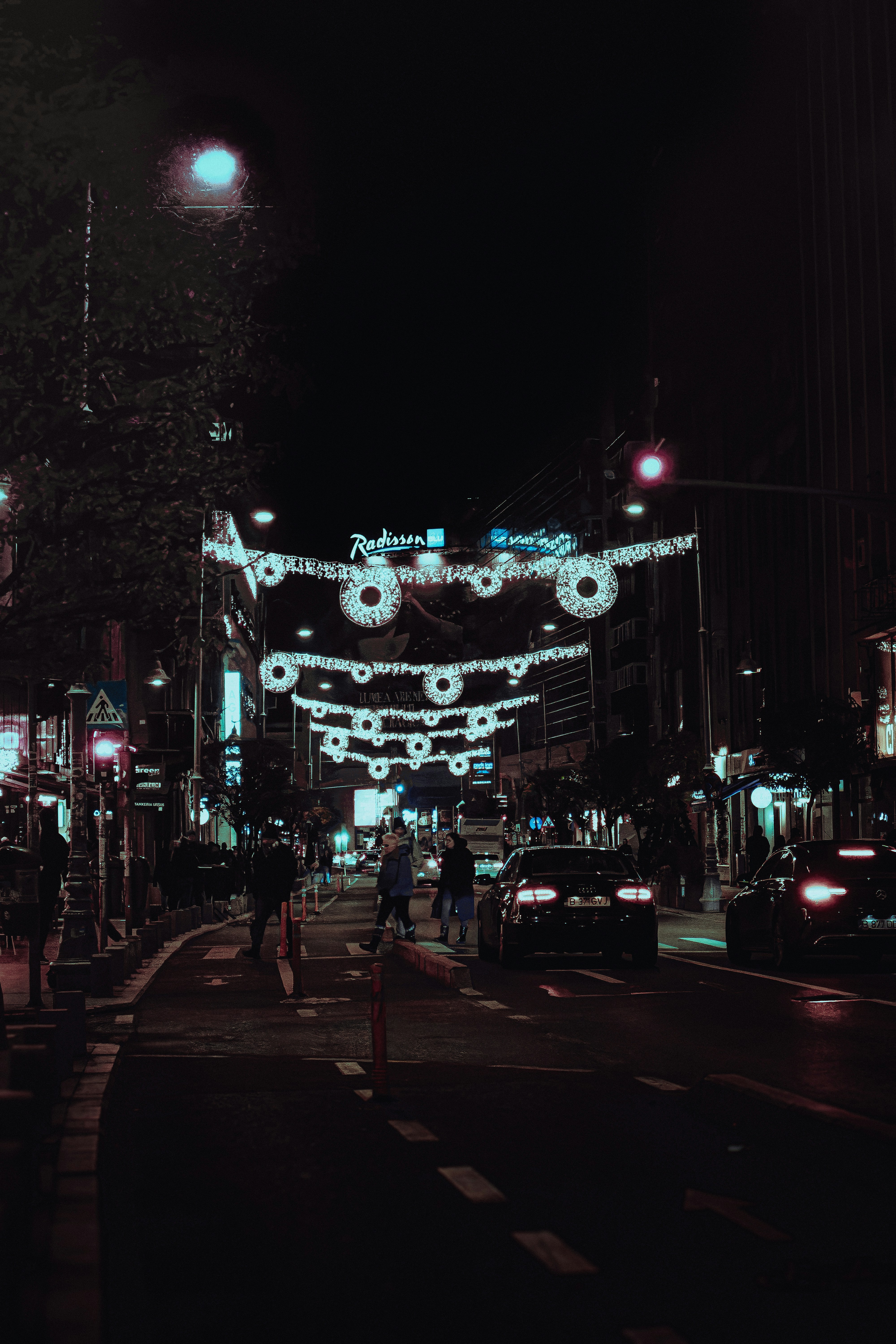 Ringed Lanterns Drift Over a Night City Street